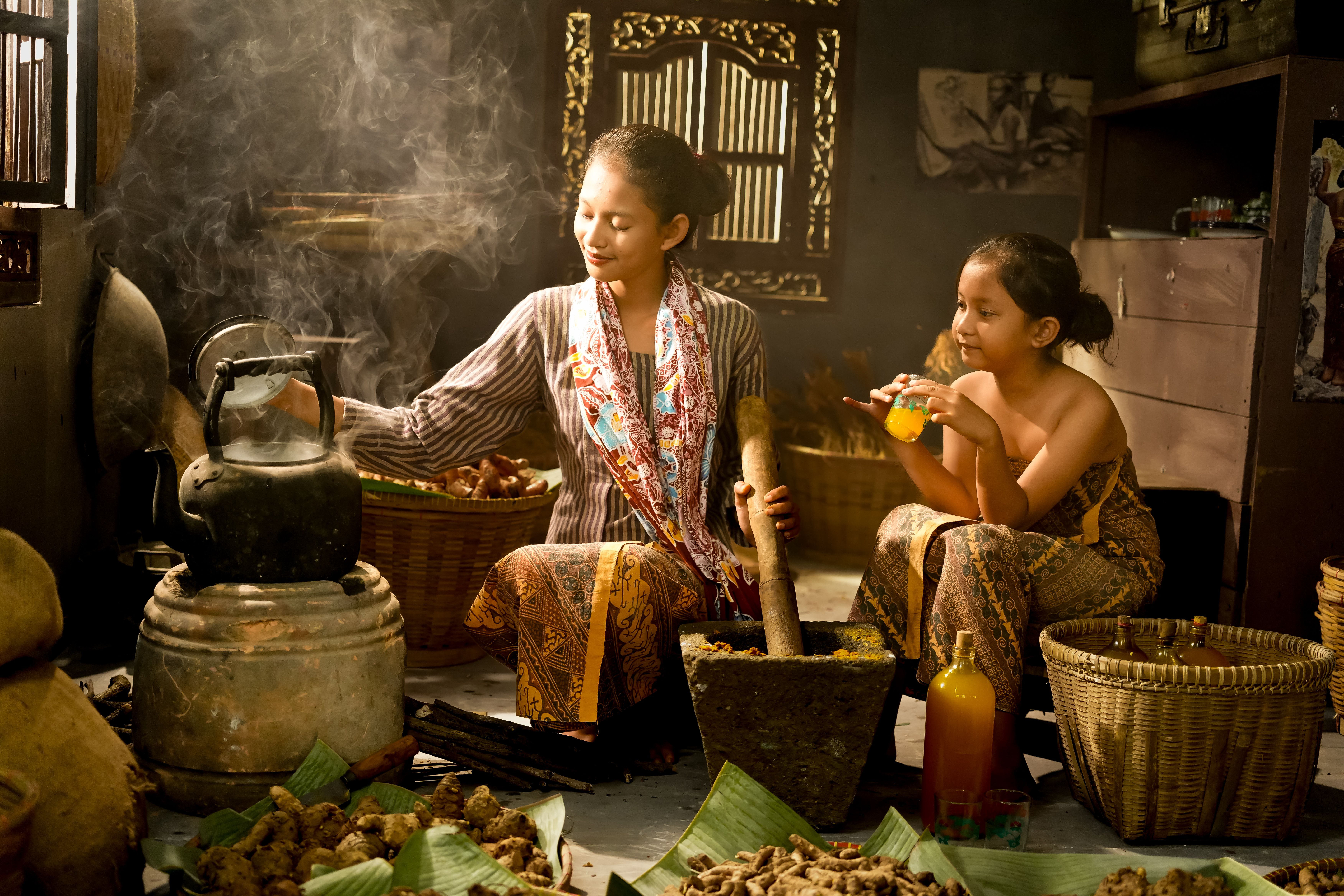 Traditional Indonesian Kitchen Scene with Family · Free Stock Photo