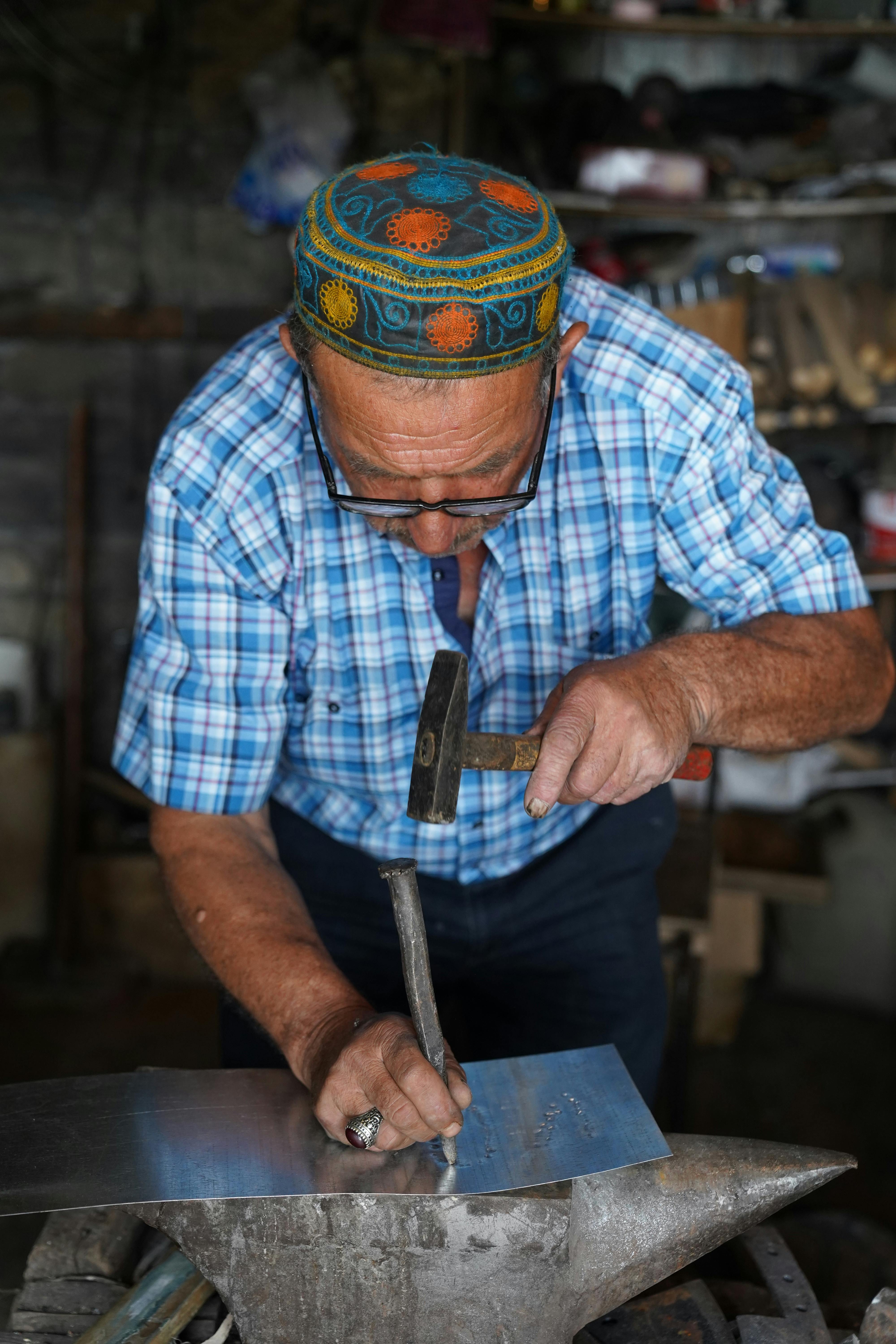 Skilled Blacksmith Hammering Metal on Anvil · Free Stock Photo
