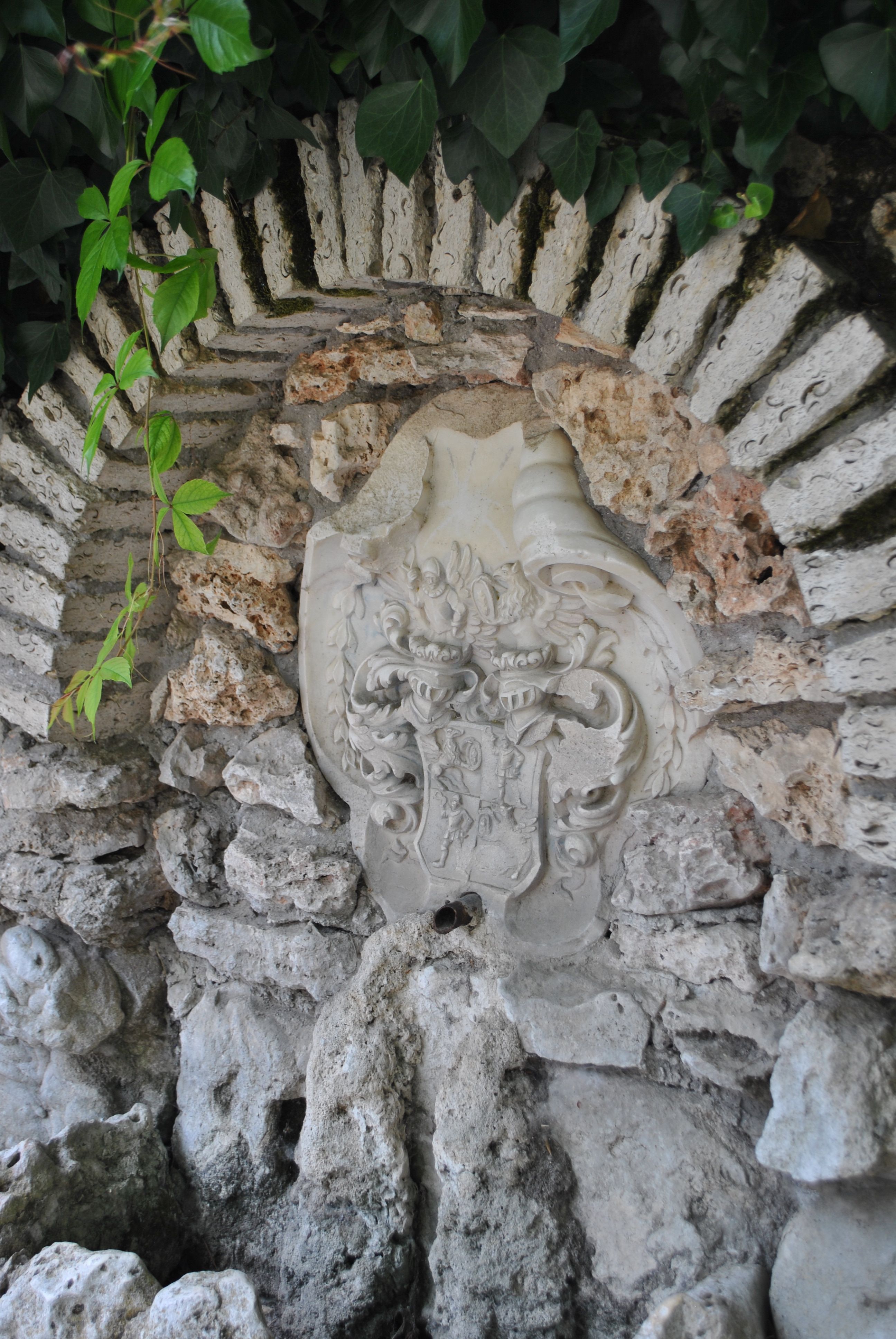 Ancient Stone Relief in Arched Wall Setting · Free Stock Photo