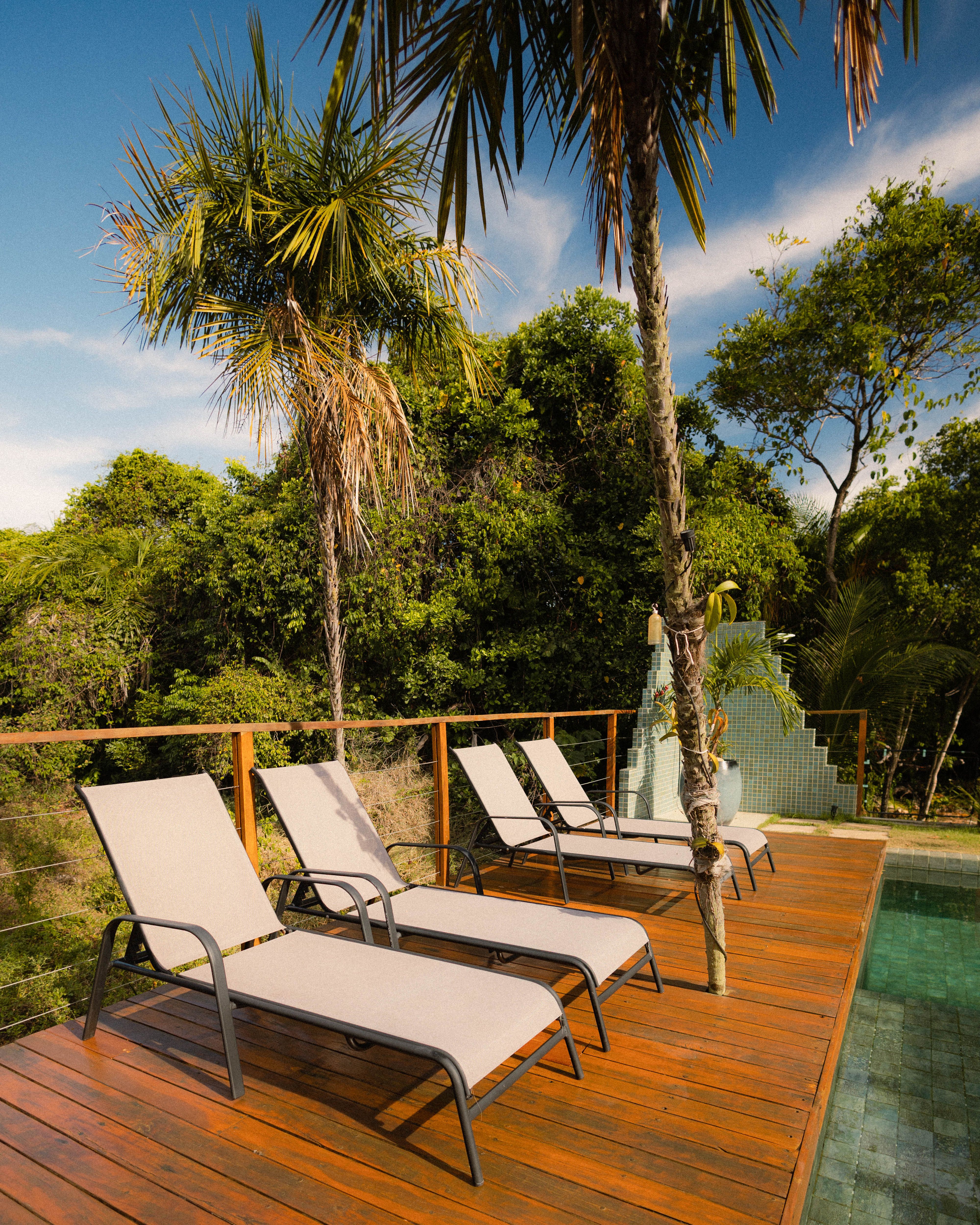 Luxurious Outdoor Poolside Deck with Sun Loungers · Free Stock Photo