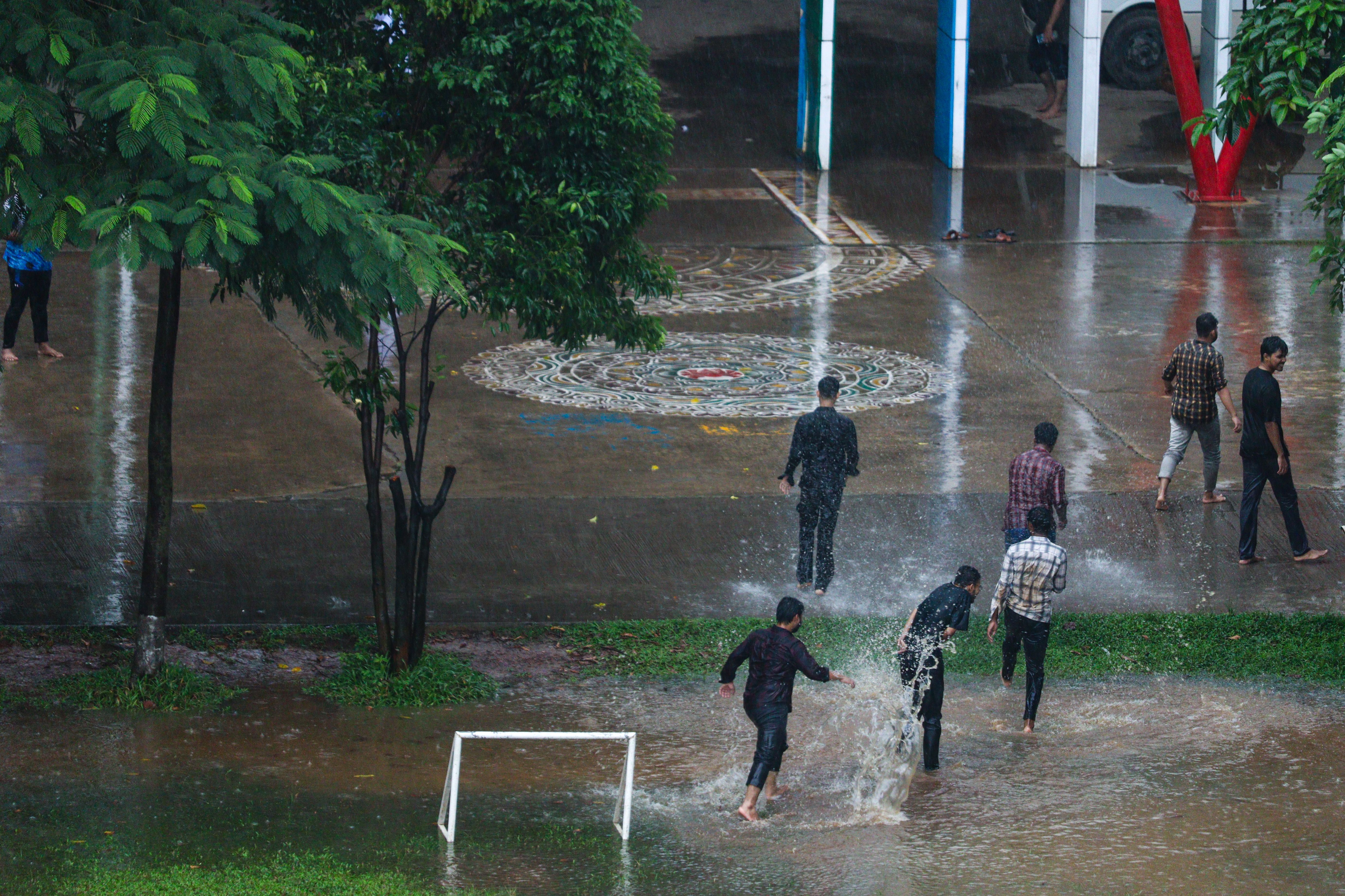 Children Playing in Puddles During Rain · Free Stock Photo