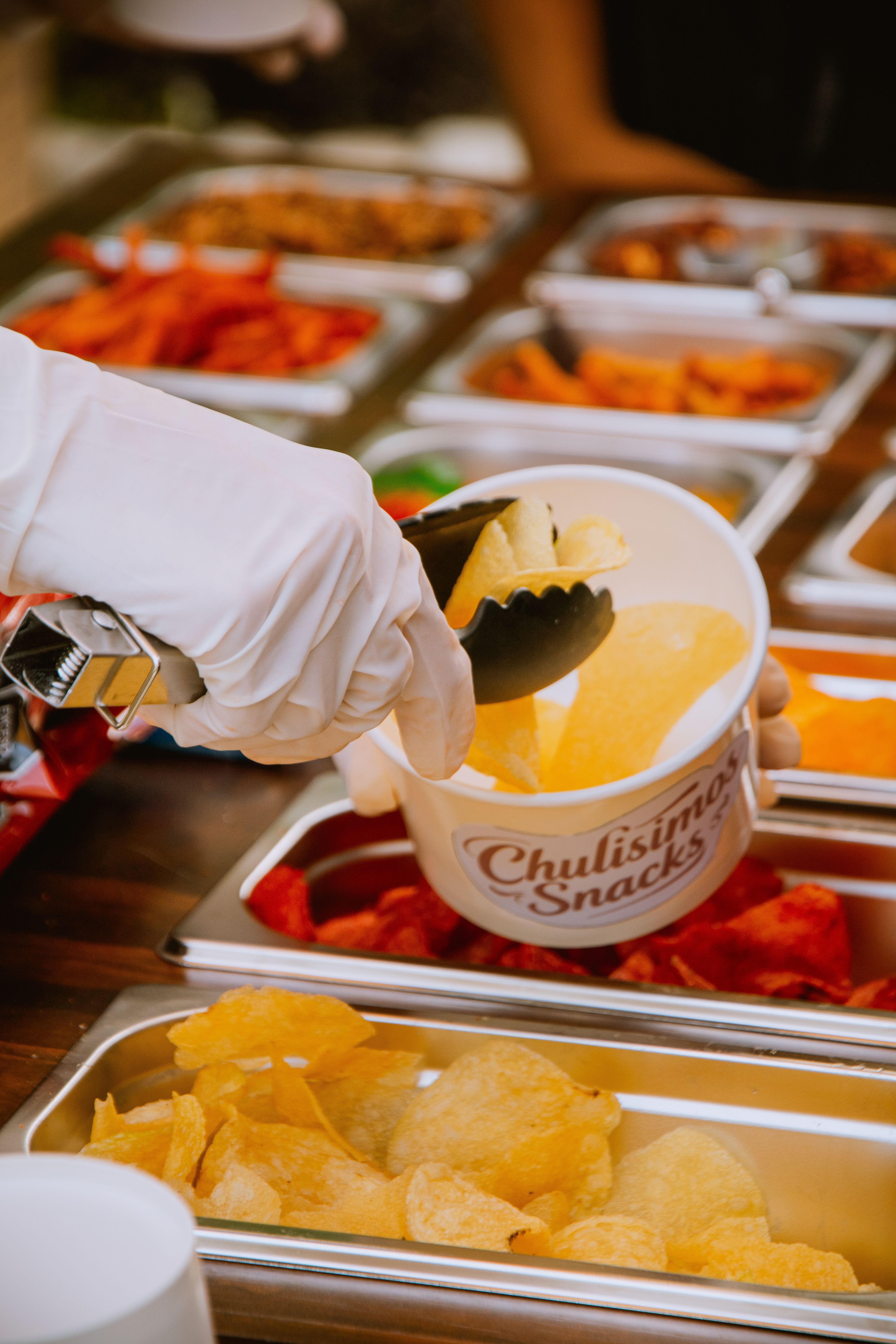 Person Serving Potato Chips at Snack Bar · Free Stock Photo