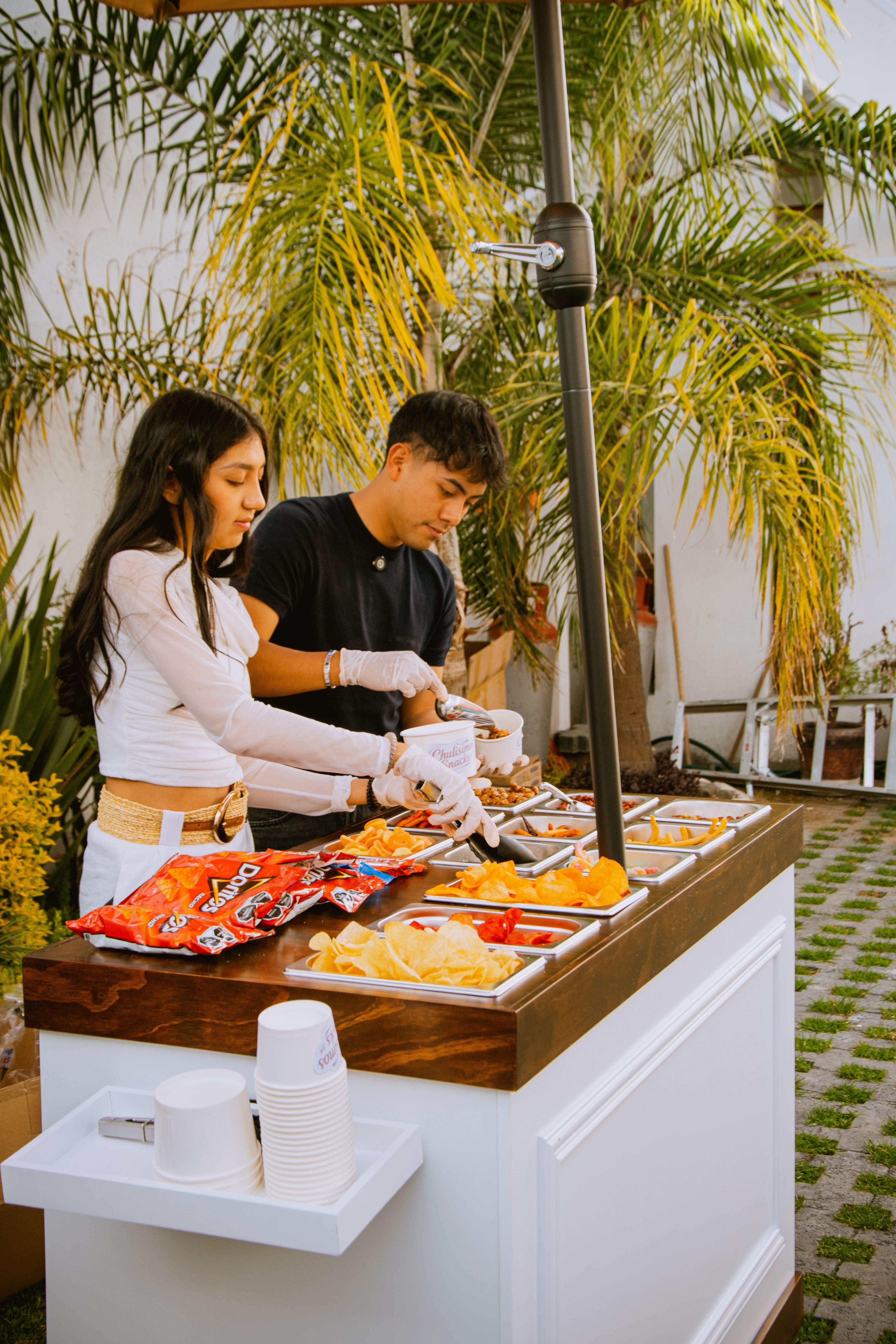 Outdoor Food Stand with Young Adults Serving · Free Stock Photo