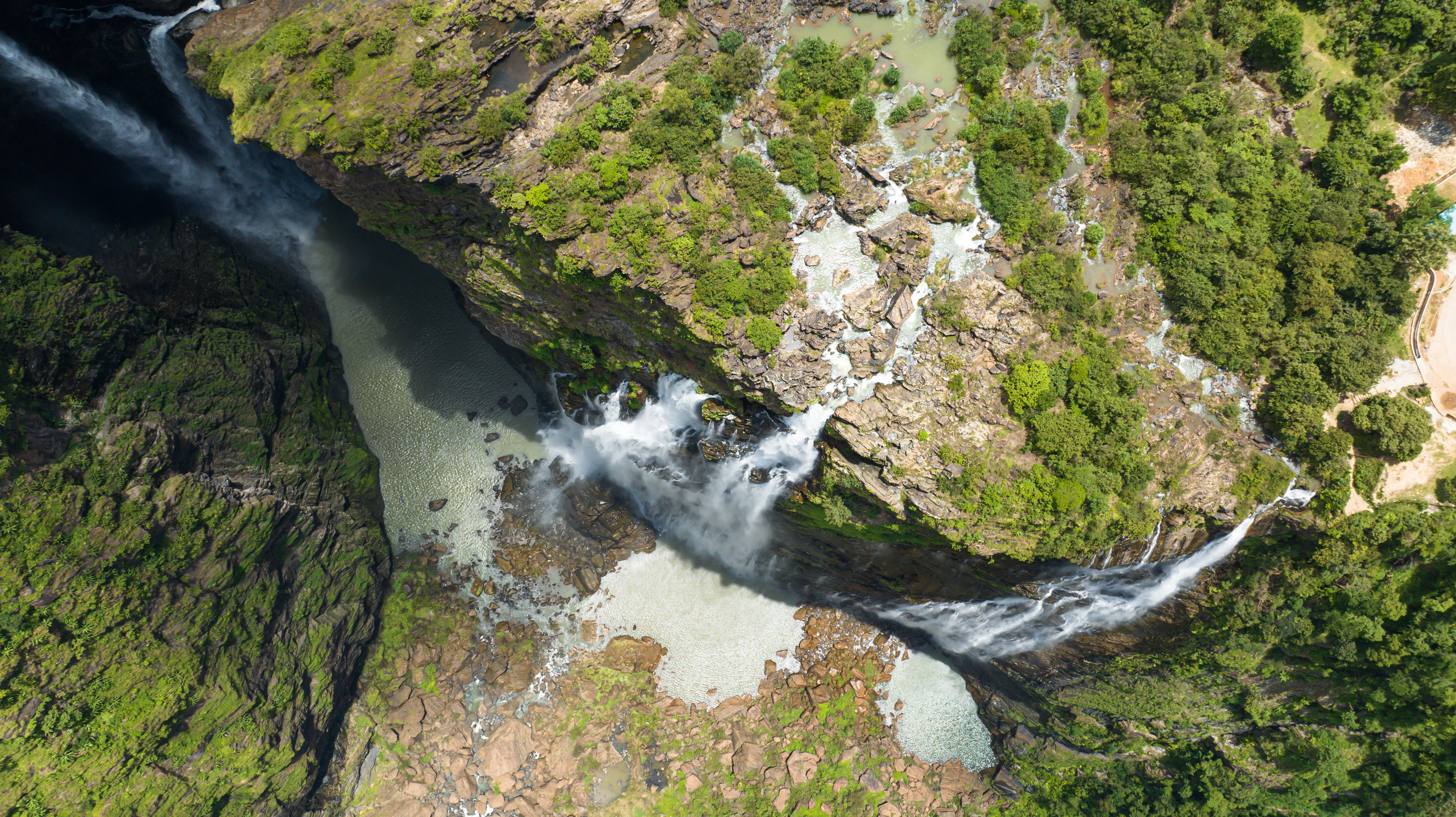 Aerial View of Majestic Waterfall and Gorge · Free Stock Photo