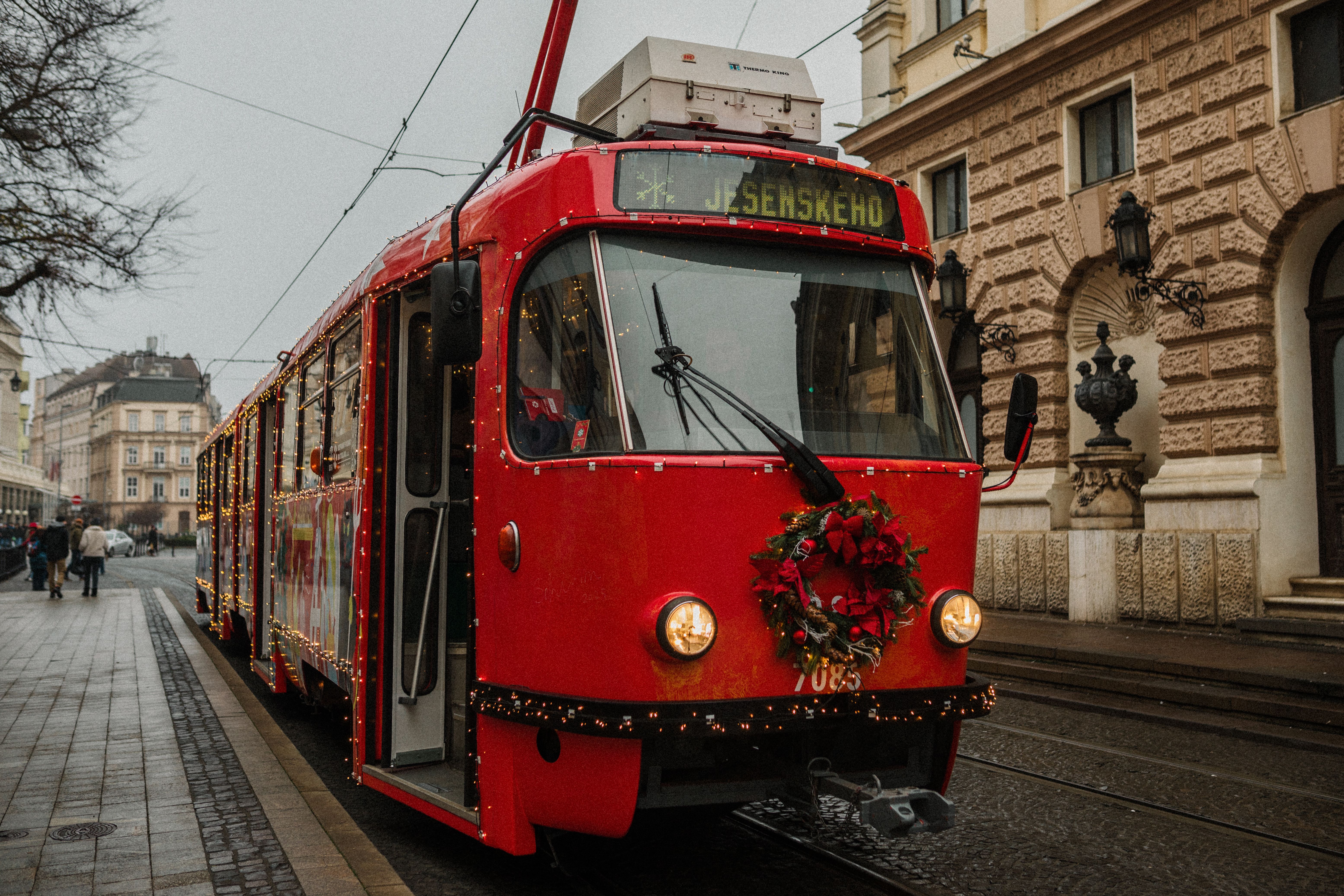 Festive Red Tram Decorated for Christmas in City Street · Free Stock Photo