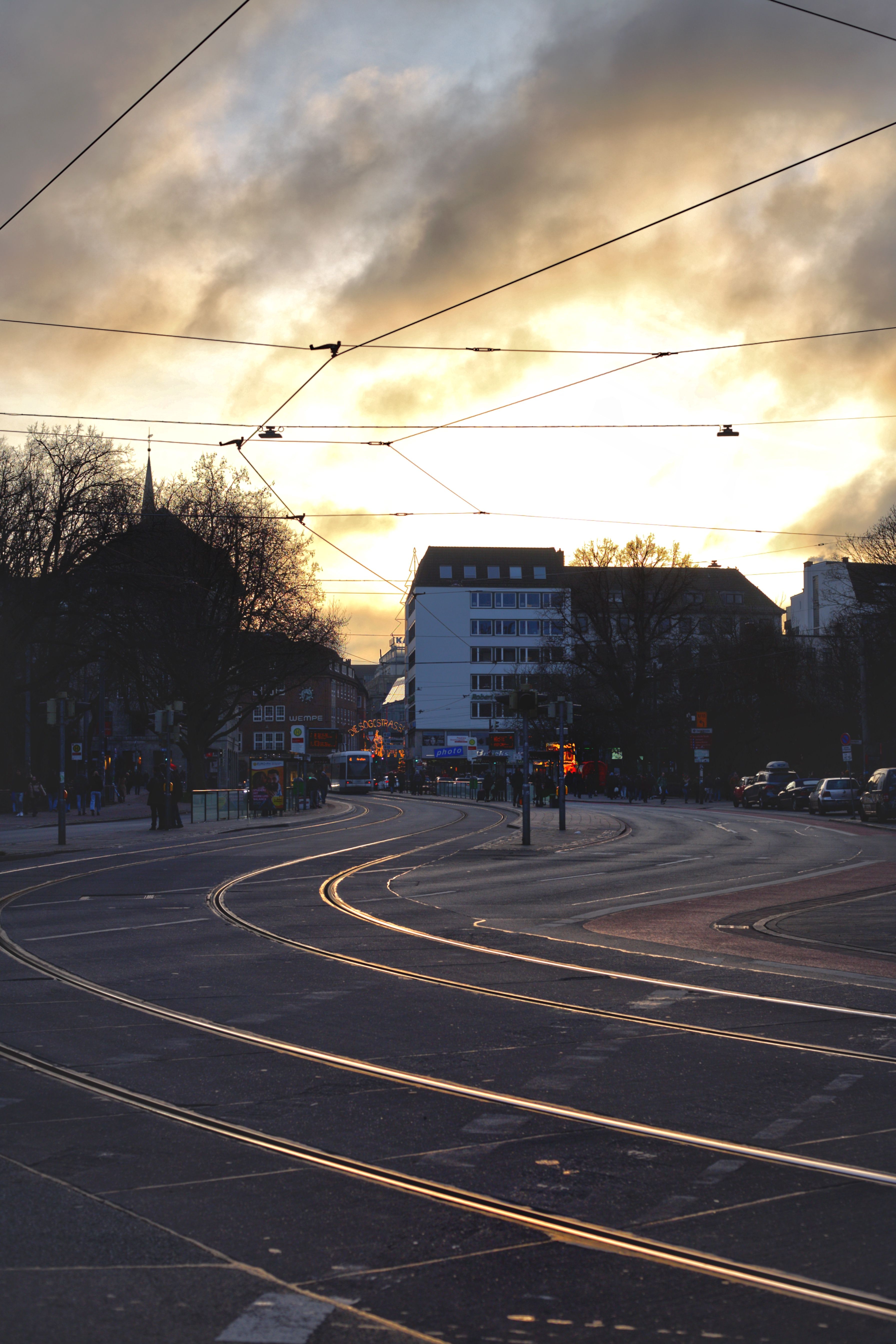 Urban Street Scene at Dusk with Tram Tracks · Free Stock Photo