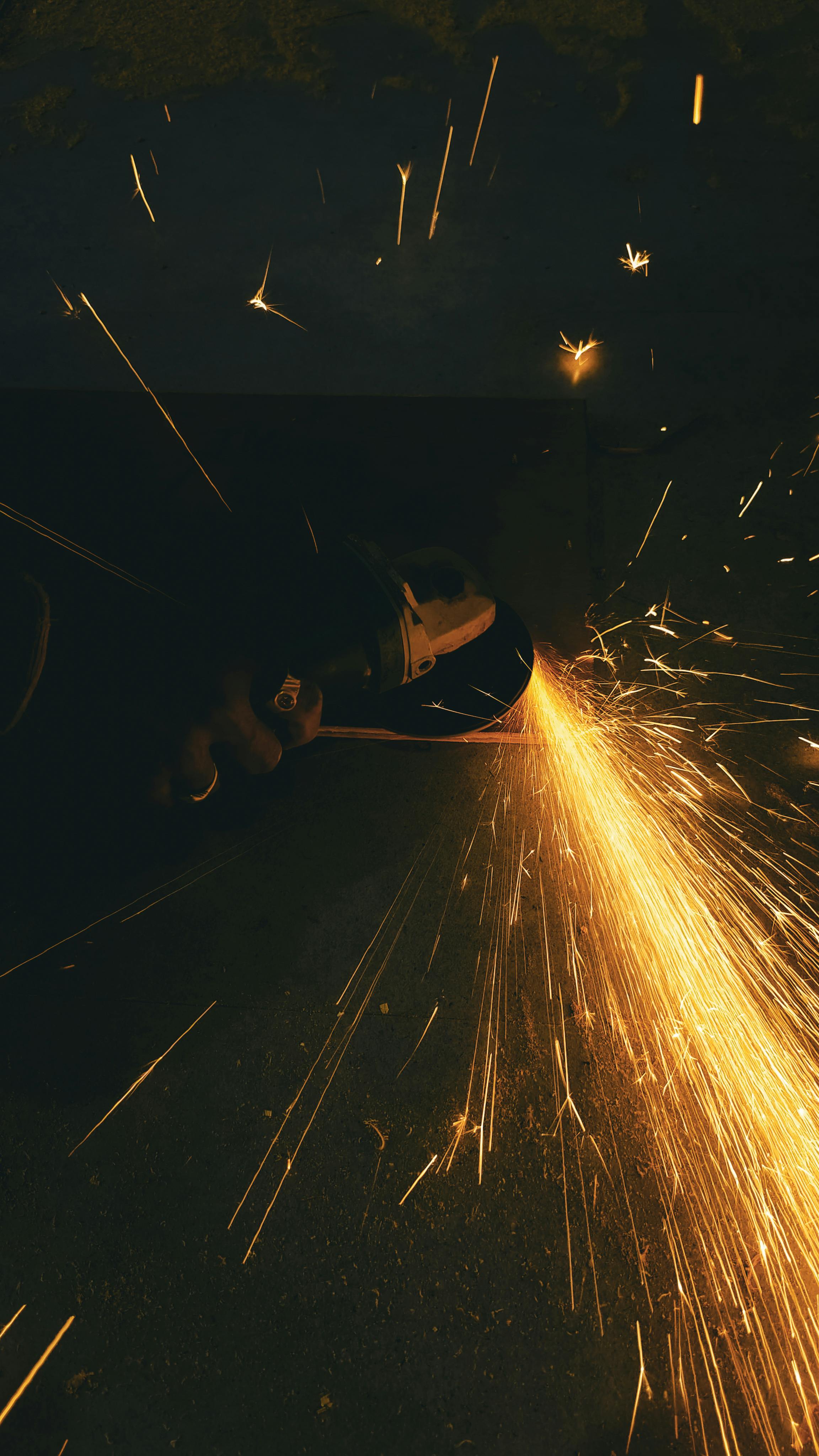 Industrial Worker Using Angle Grinder at Night · Free Stock Photo