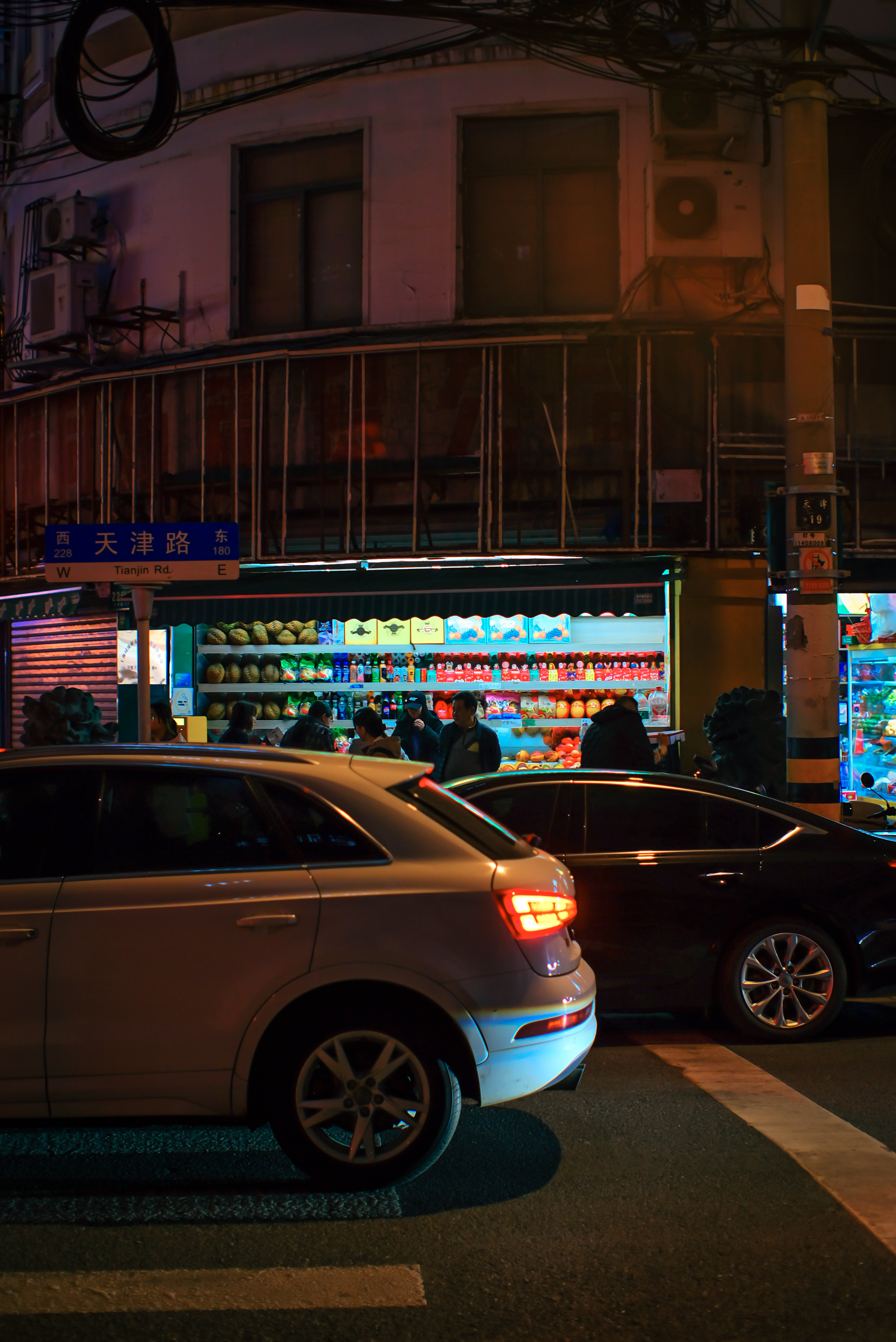 Nighttime Street Scene with Illuminated Storefront · Free Stock Photo