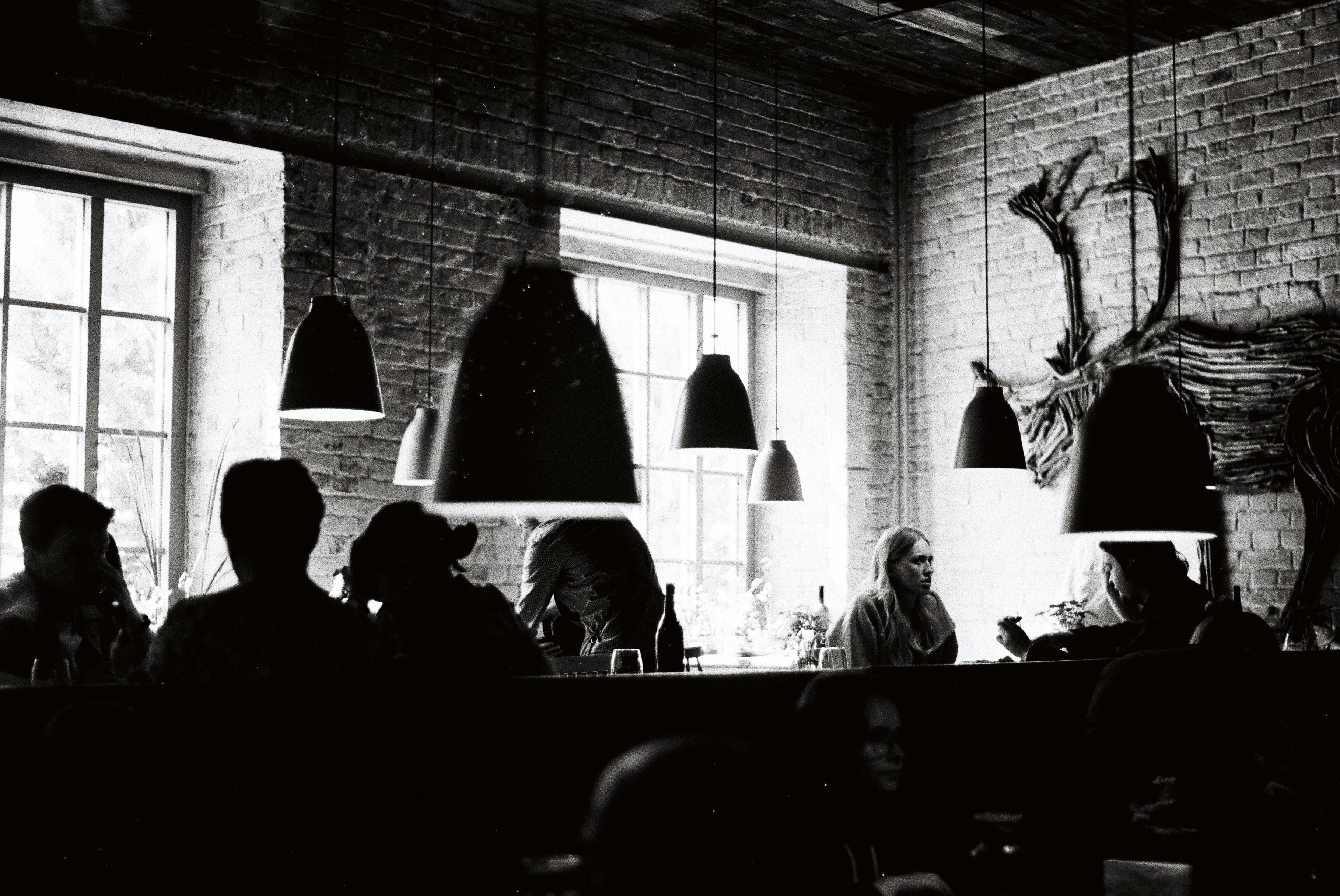 Black and White Indoor Cafe Scene with Patrons · Free Stock Photo
