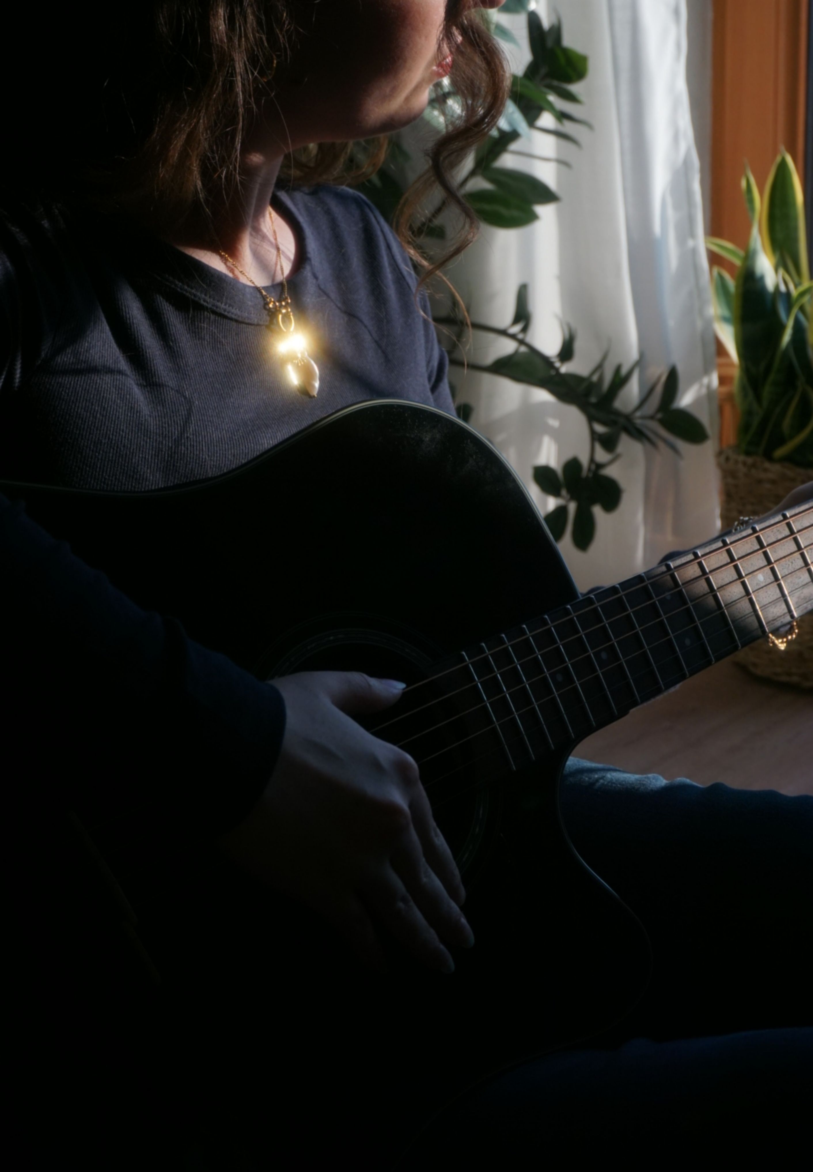 Woman Playing Guitar by Sunlit Window · Free Stock Photo