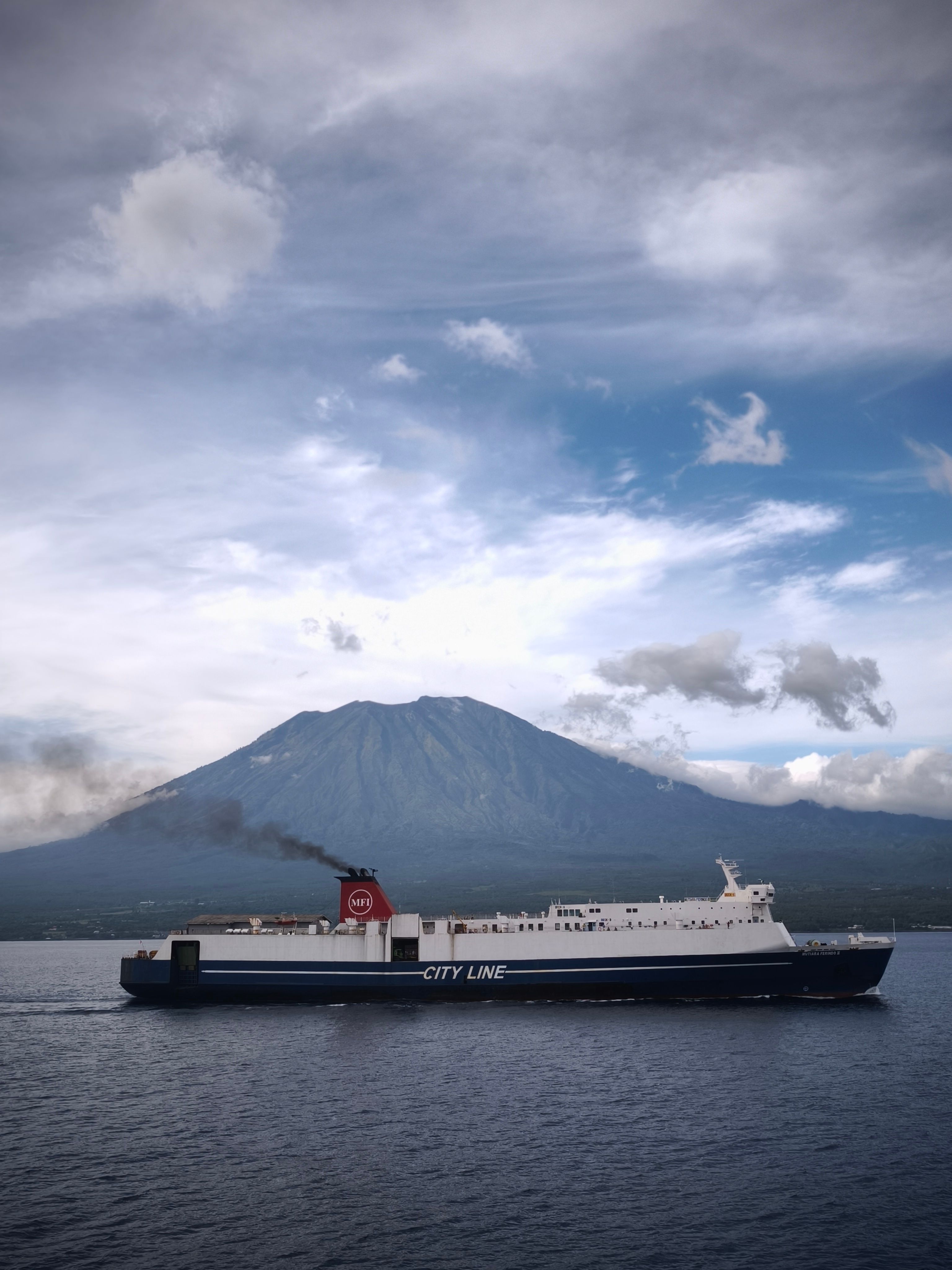 Passenger ferry with volcano backdrop · Free Stock Photo
