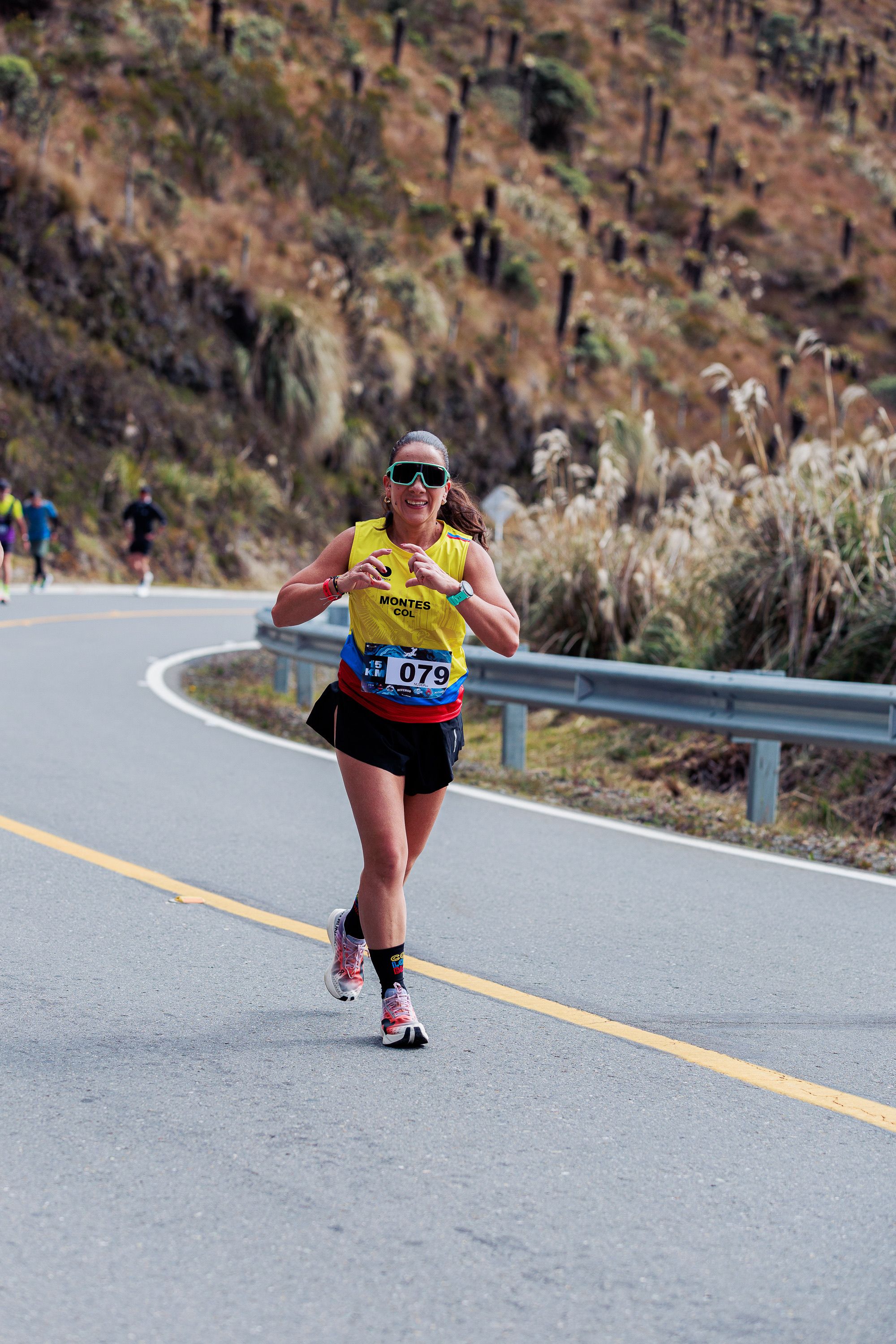 Female Marathon Runner on Mountain Road · Free Stock Photo