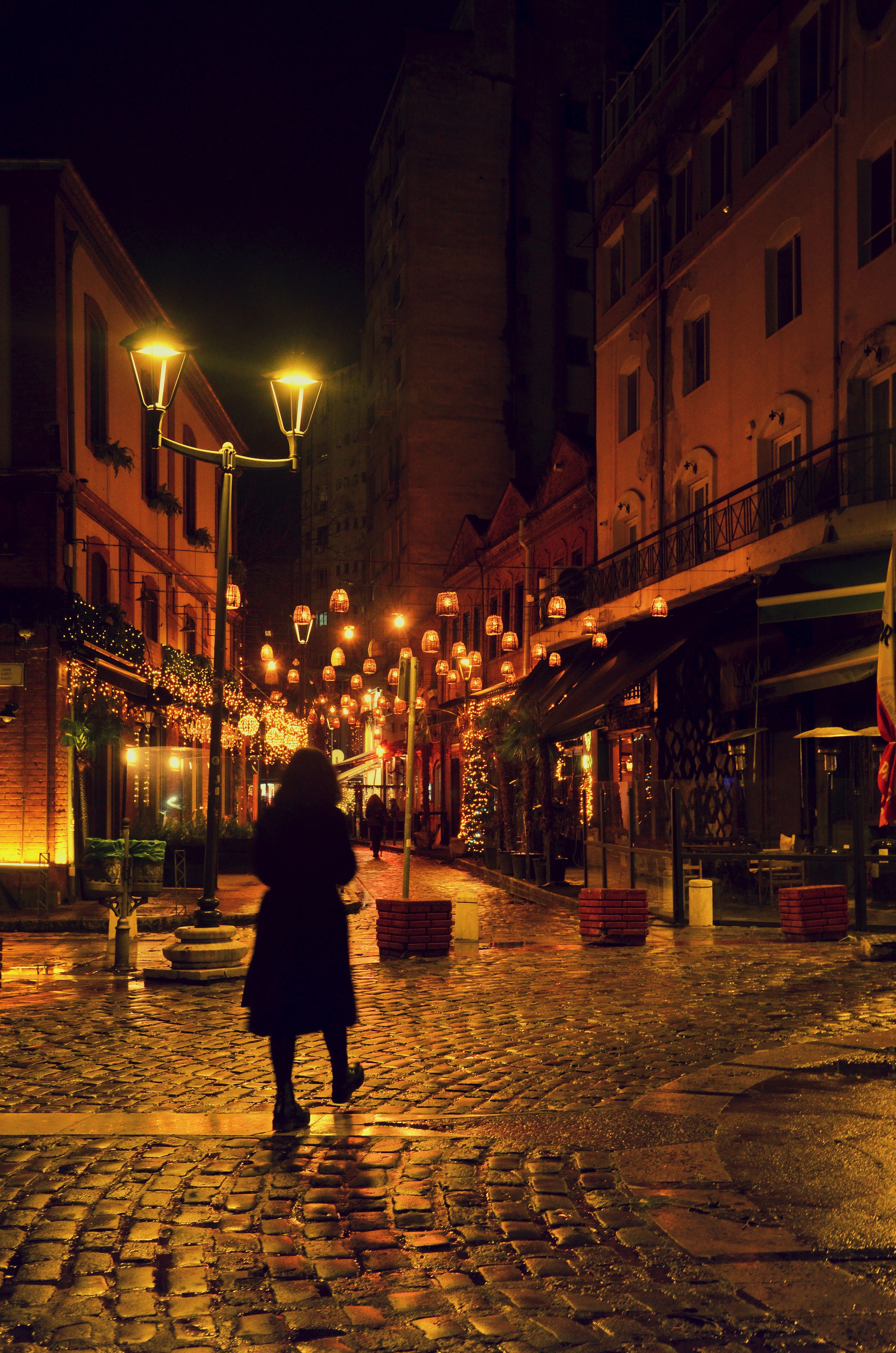 Cozy Night Stroll in Illuminated European Alley · Free Stock Photo