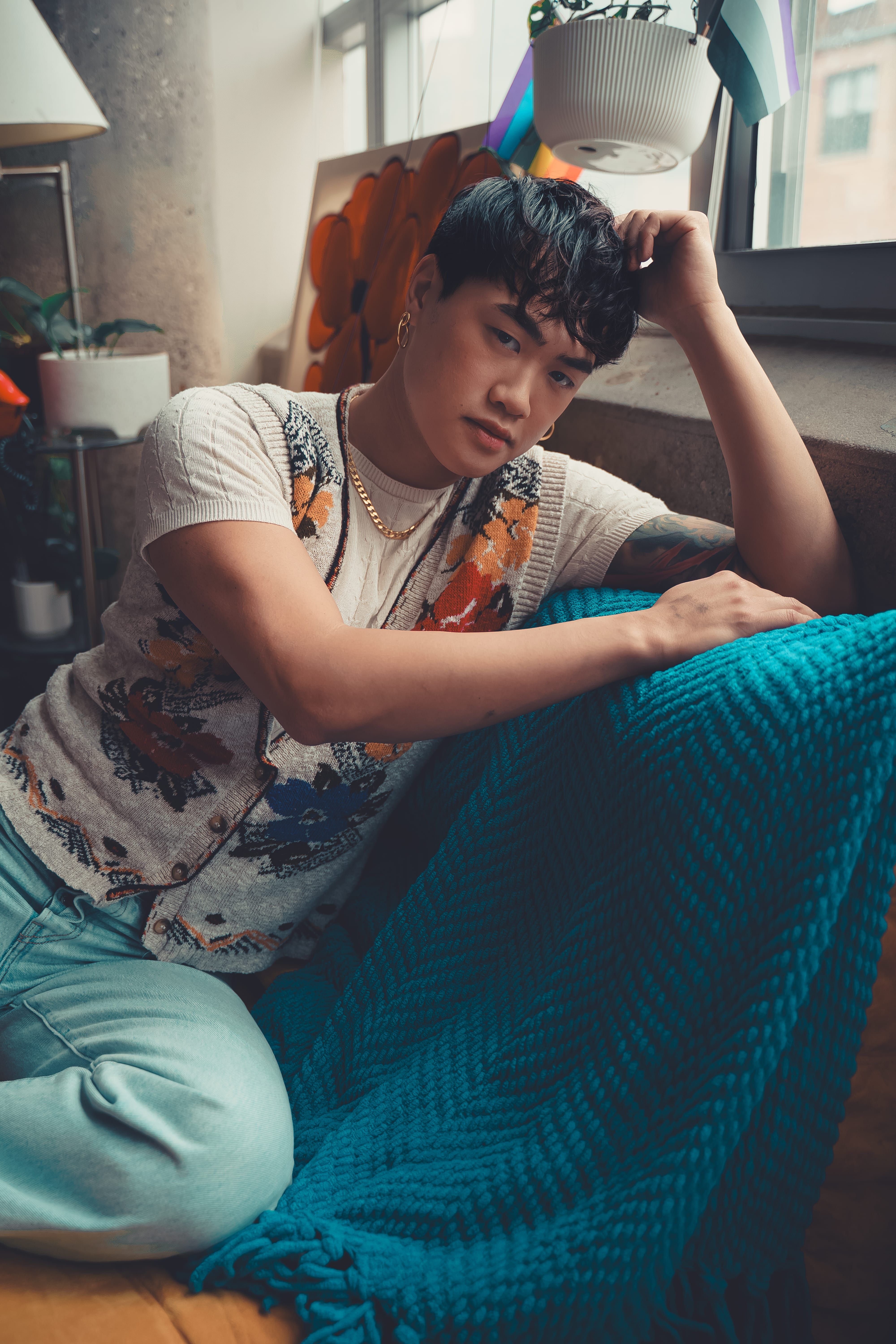 Thoughtful Young Adult Relaxing Indoors · Free Stock Photo