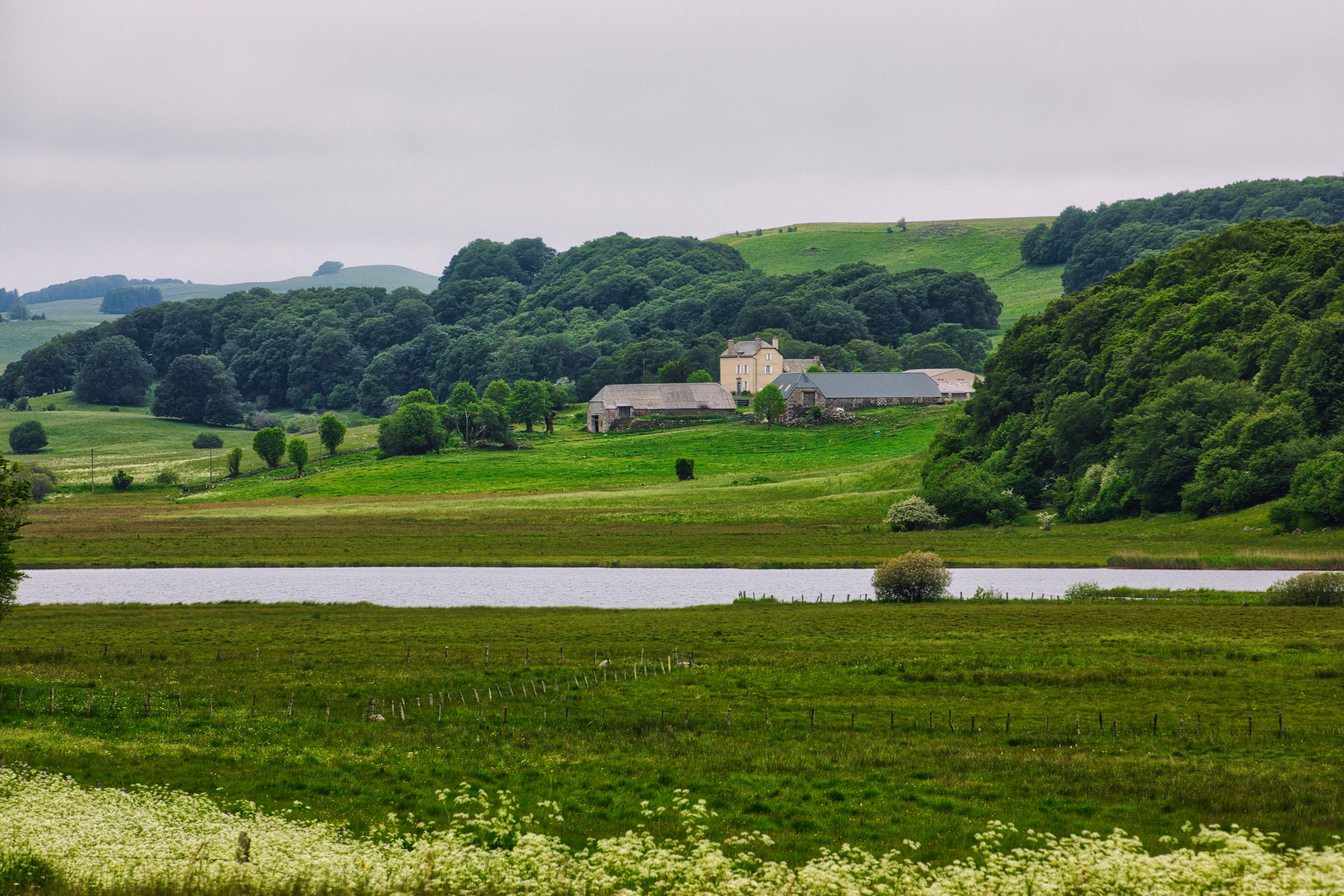 Serene French Countryside with Farmhouse and River · Free Stock Photo