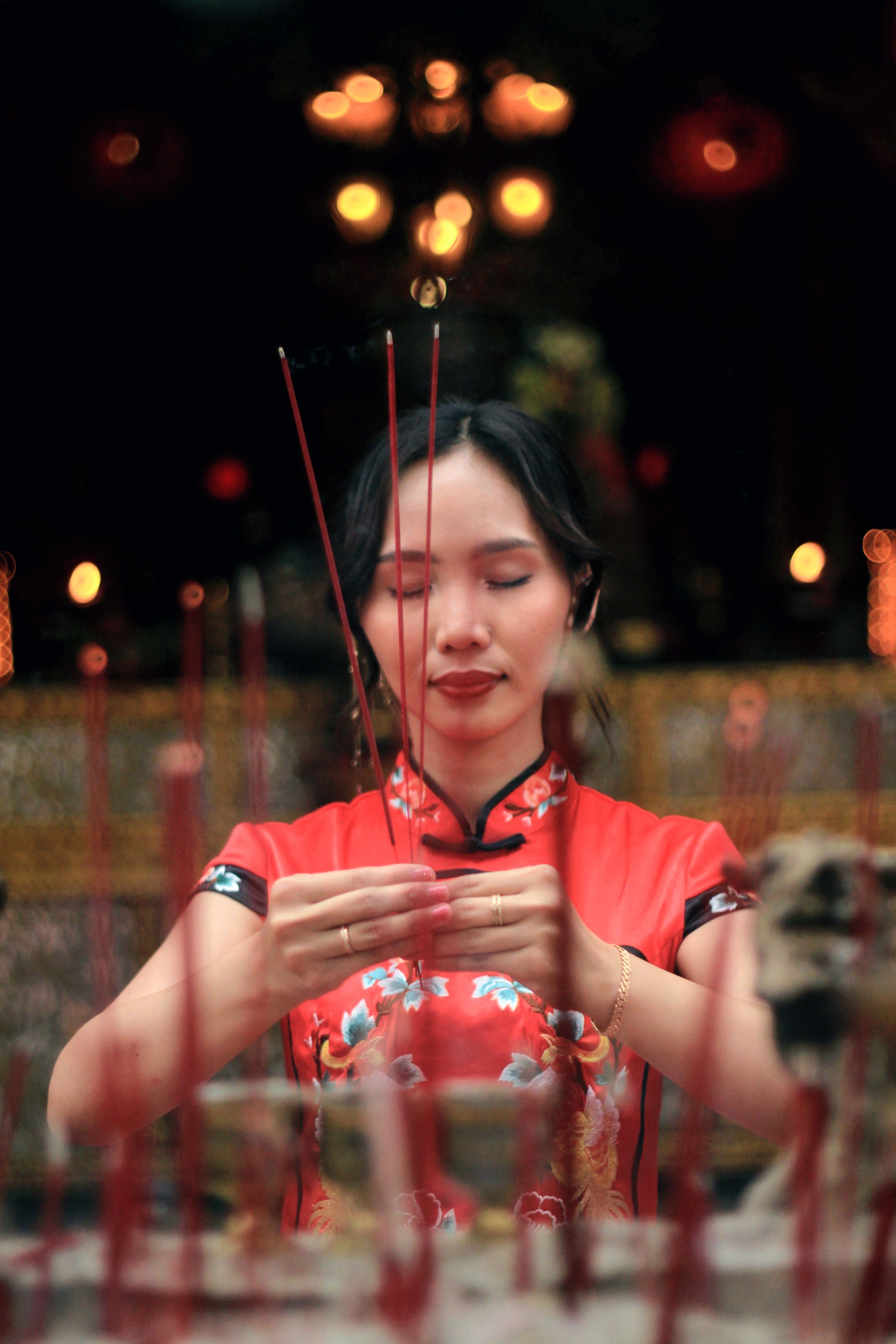 Woman Performing Incense Ritual in Traditional Dress · Free Stock Photo