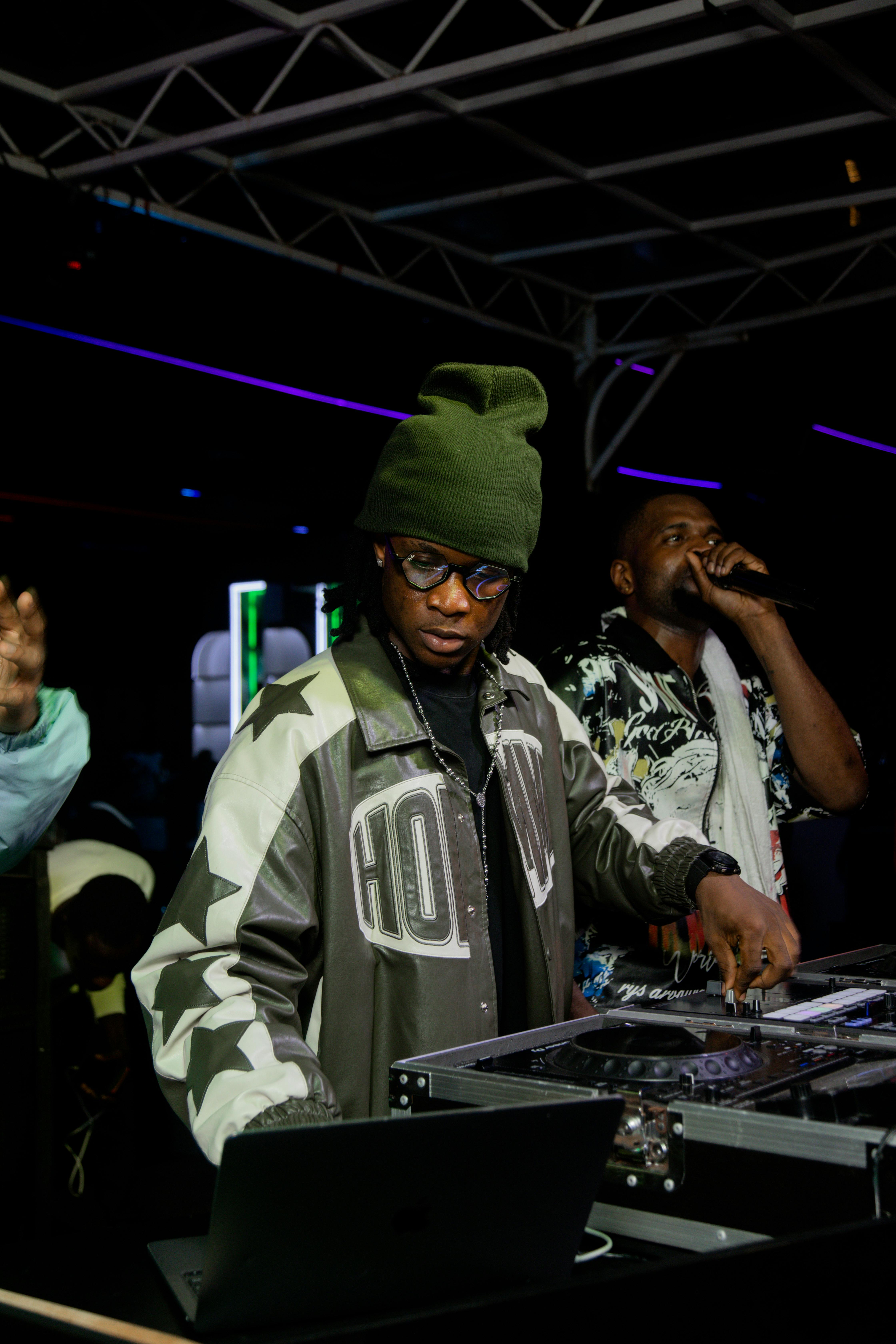 DJ Performing at Nightclub with Microphone · Free Stock Photo