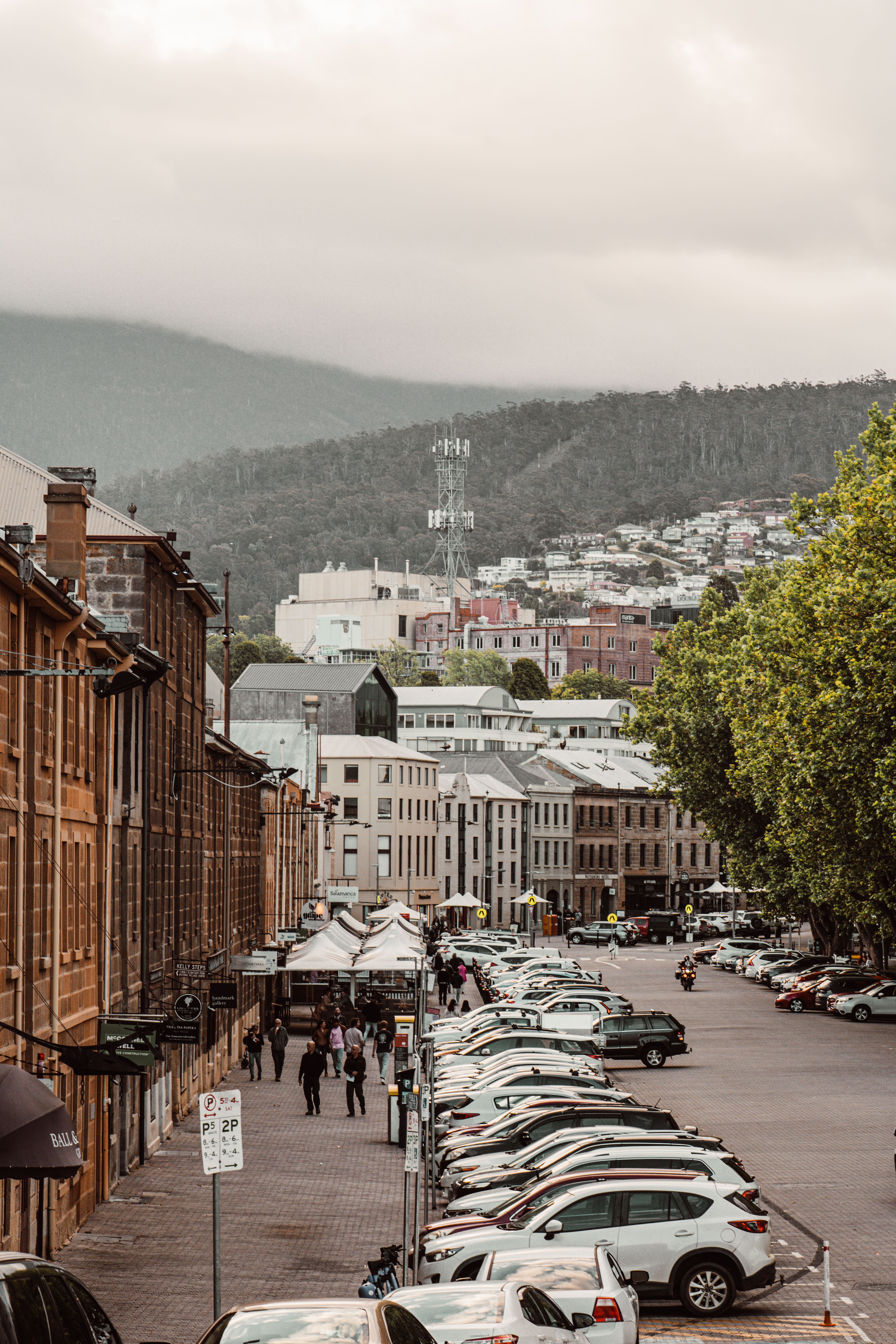 Historic Street View with Market Stalls and Cars · Free Stock Photo