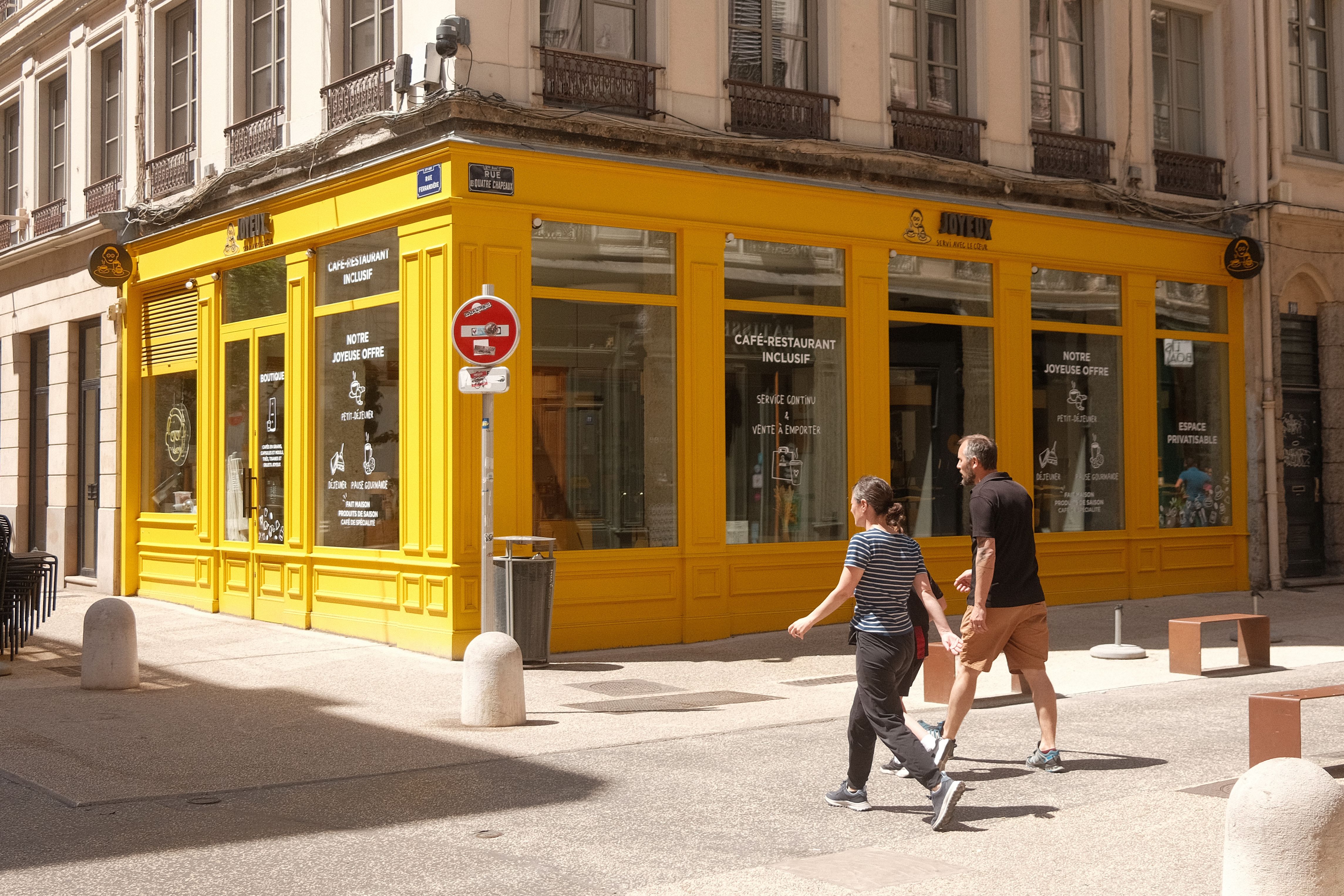 Pedestrians Outside Bright Yellow Cafe in Lyon · Free Stock Photo