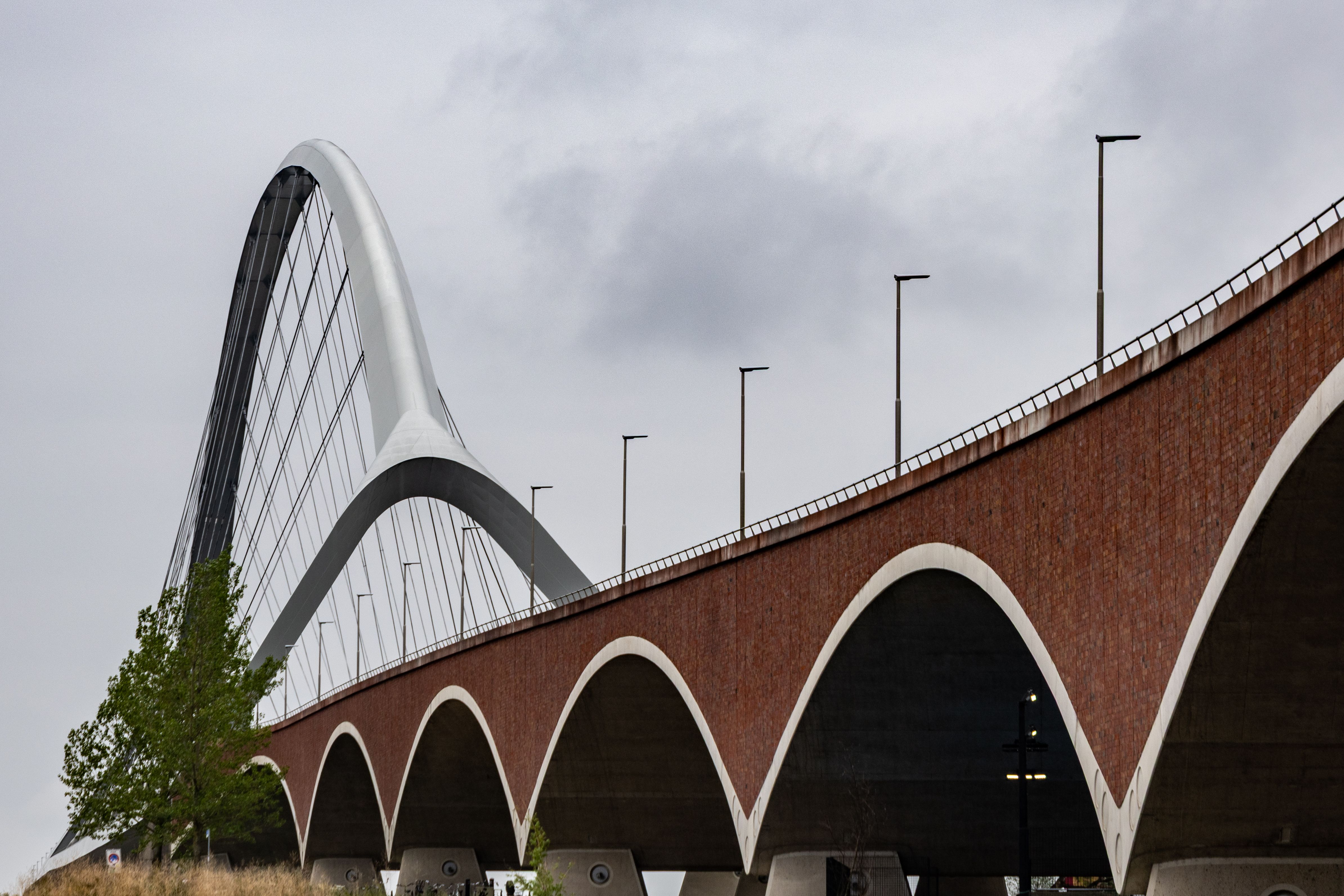 Modern Arch Bridge Against Cloudy Sky · Free Stock Photo