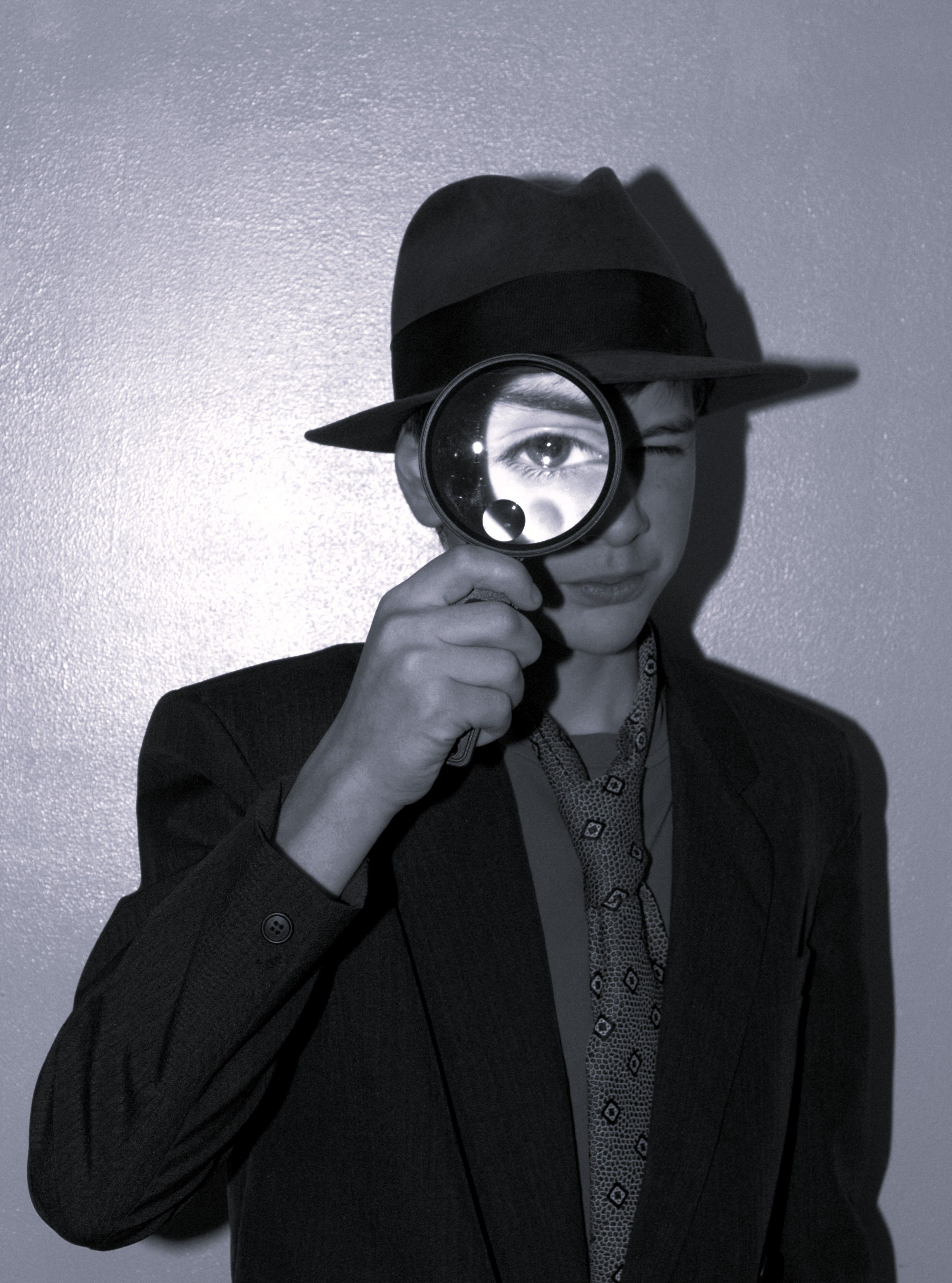 Retro Detective with Magnifying Glass in Black and White · Free Stock Photo