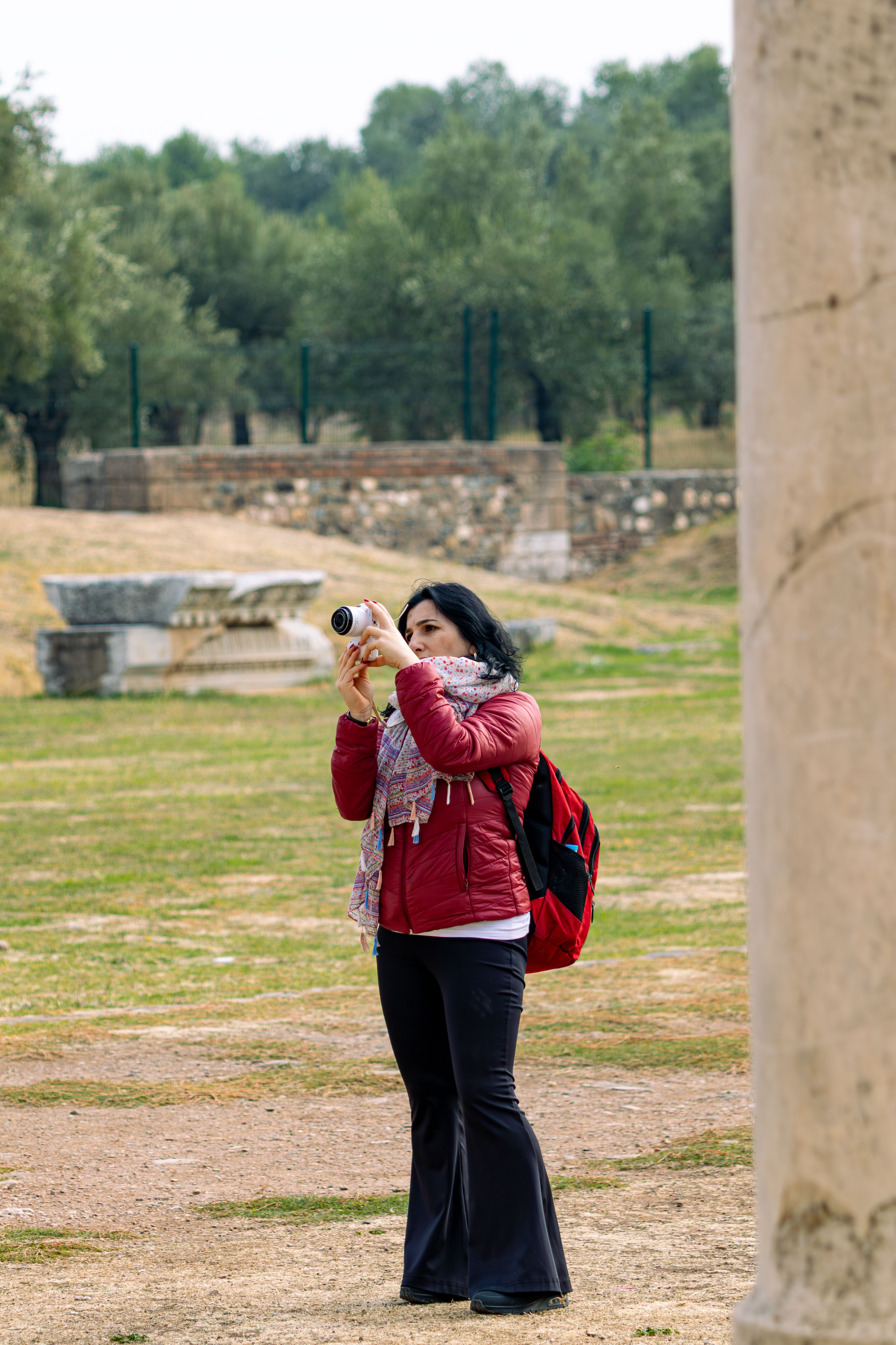 Woman Photographing Ancient Ruins Outdoors · Free Stock Photo