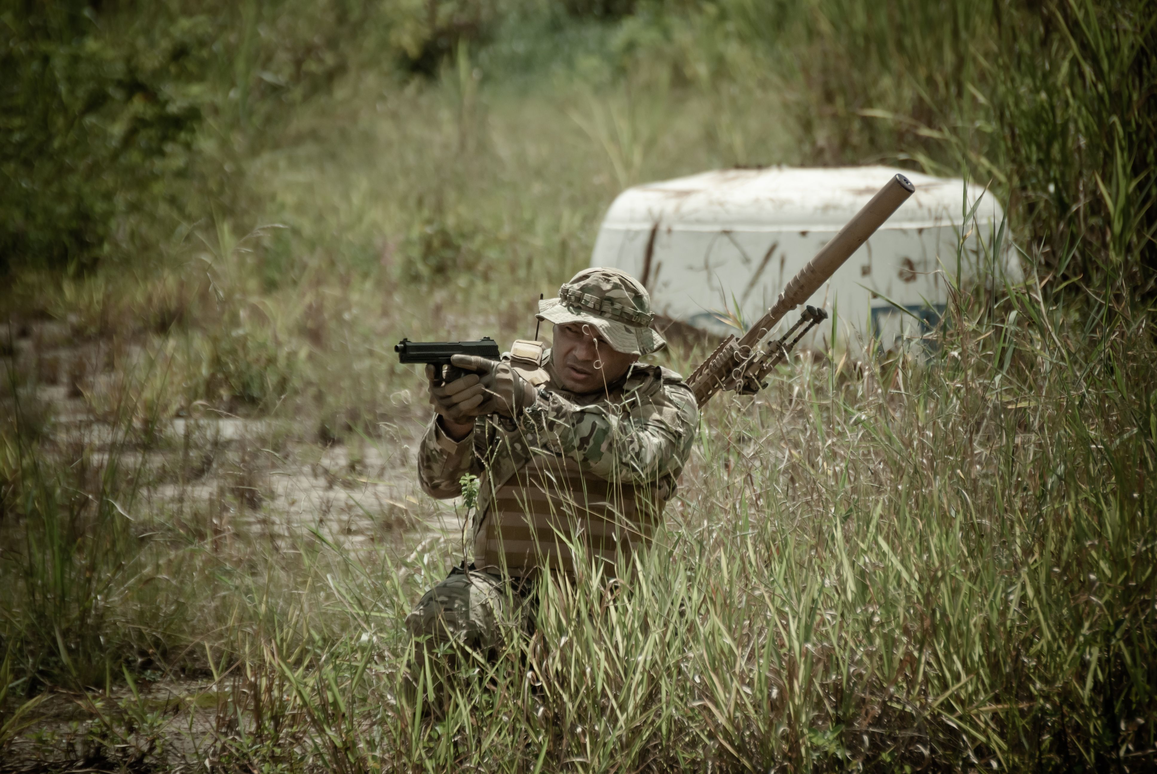 Soldier in Camouflage Aiming in Open Field · Free Stock Photo