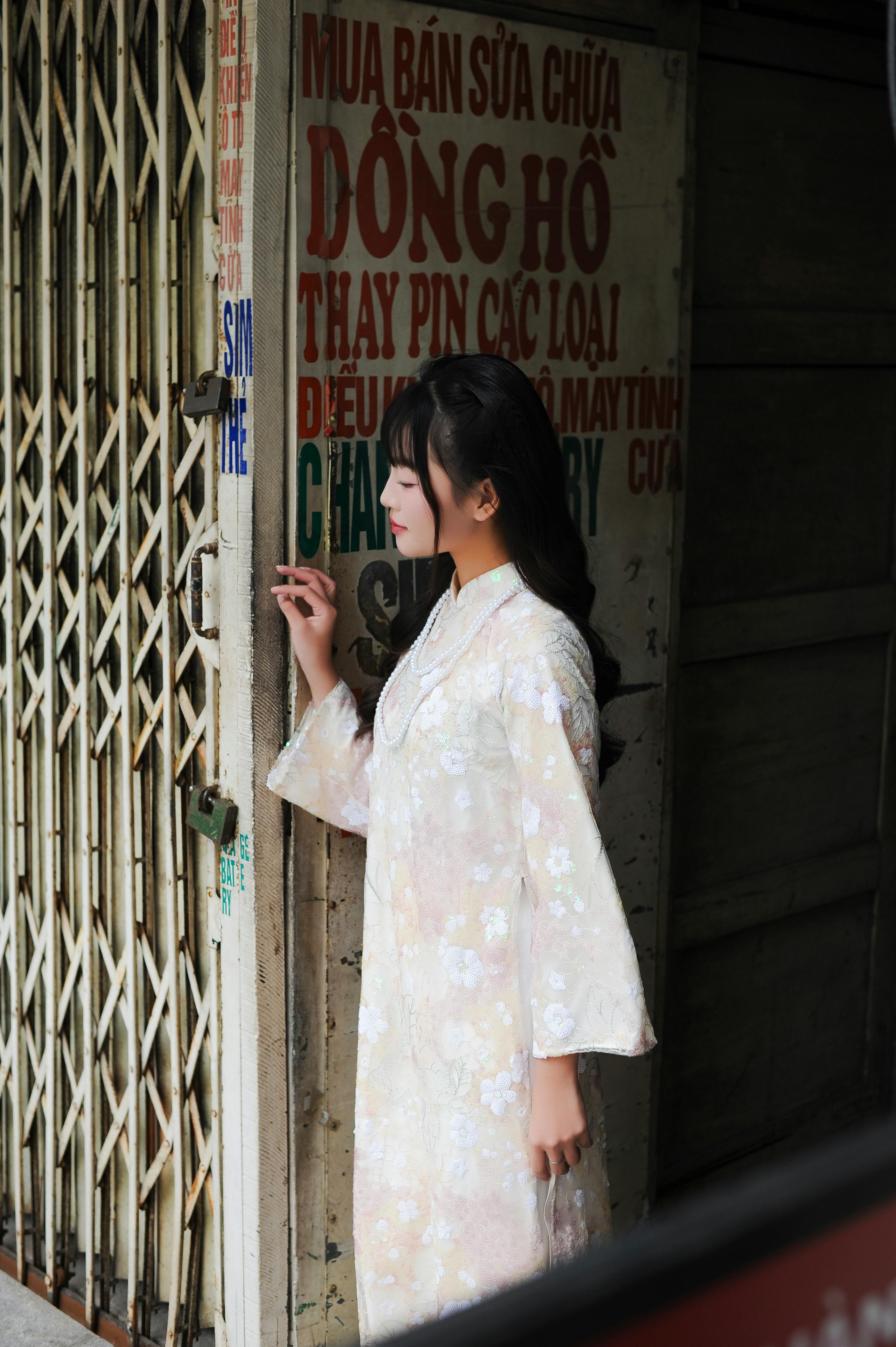 Woman in Traditional Dress Standing by Storefront · Free Stock Photo