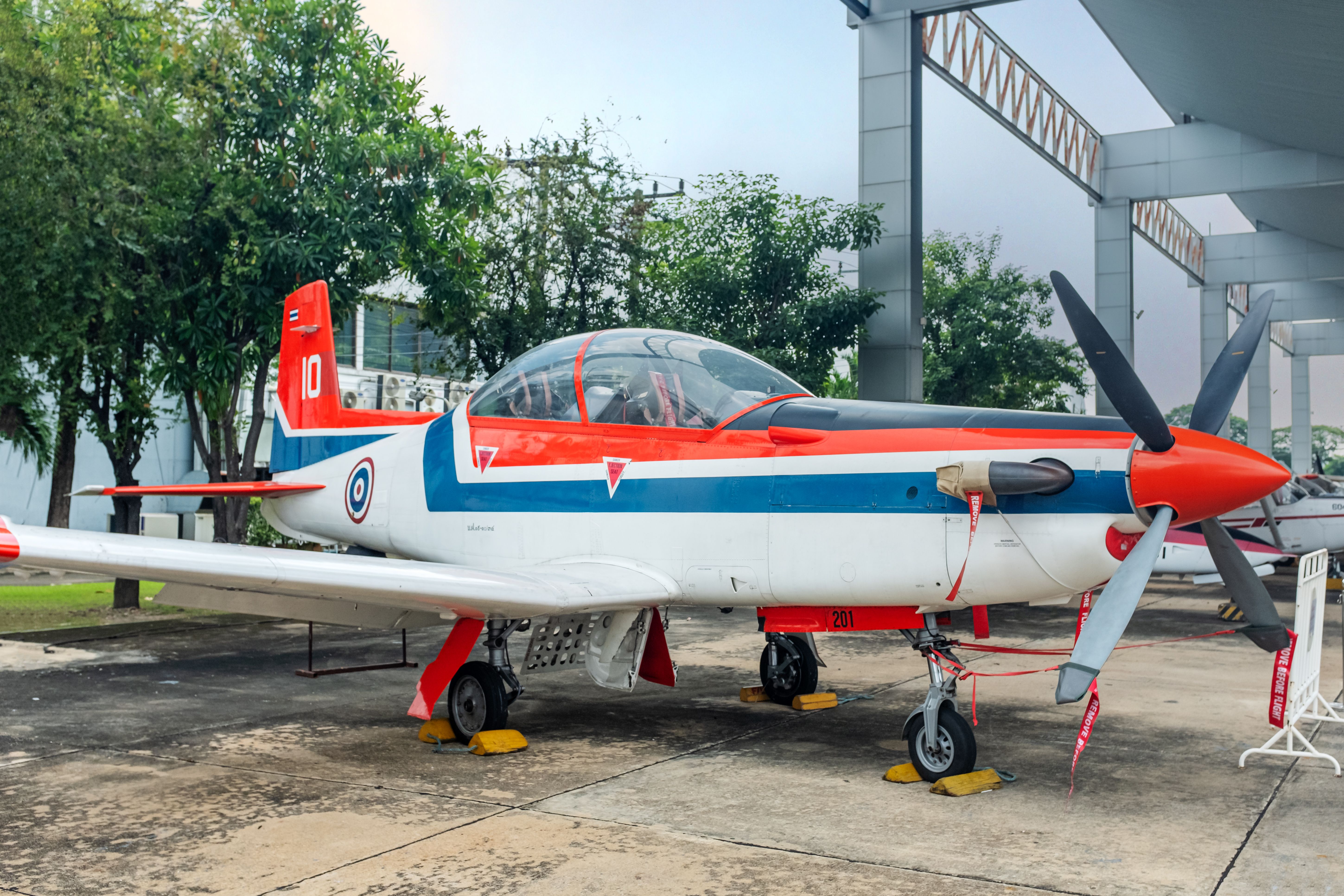 Vibrant Trainer Aircraft at Outdoor Hangar · Free Stock Photo