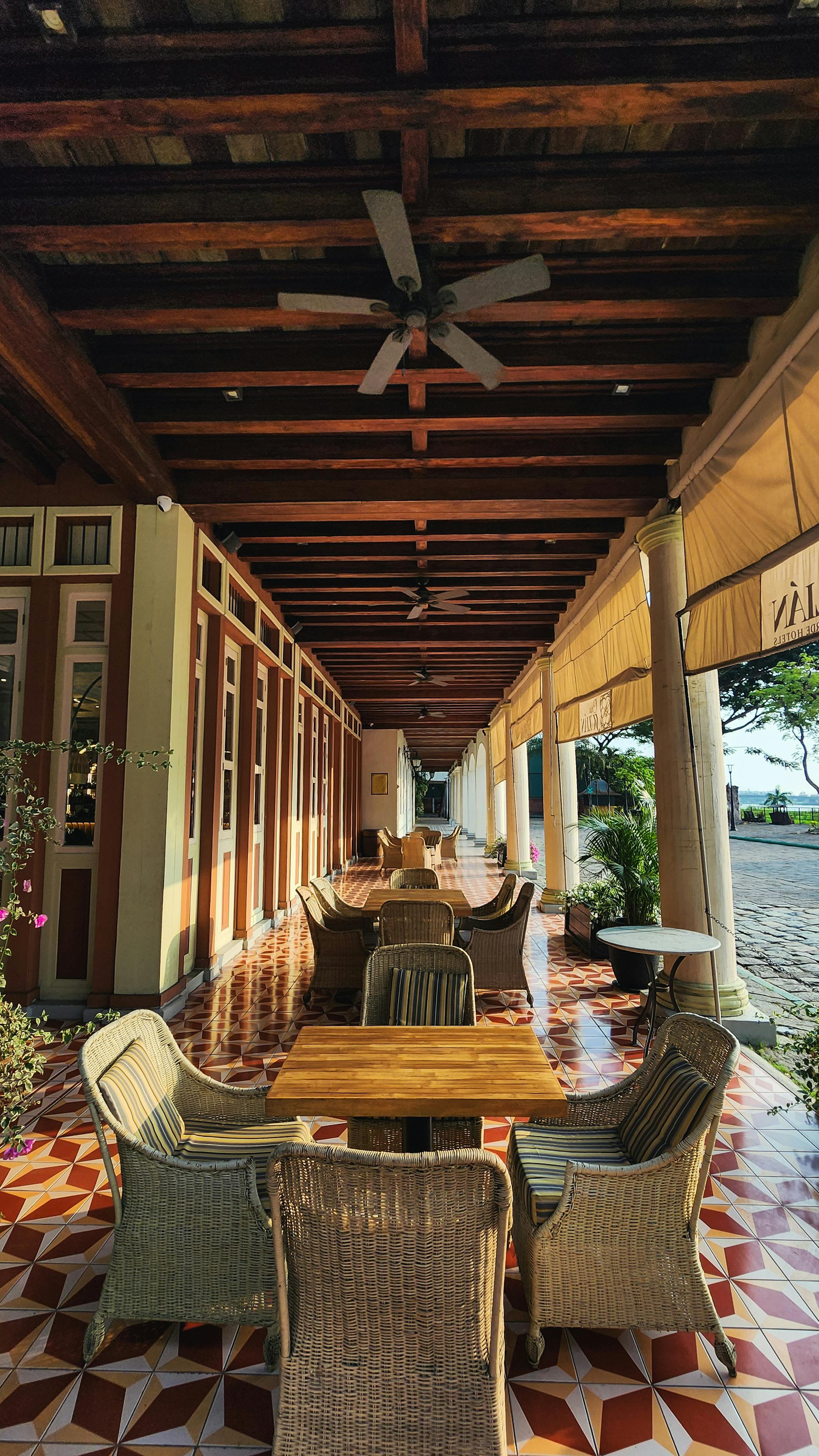 Charming Outdoor Cafe by Cobblestone Path · Free Stock Photo