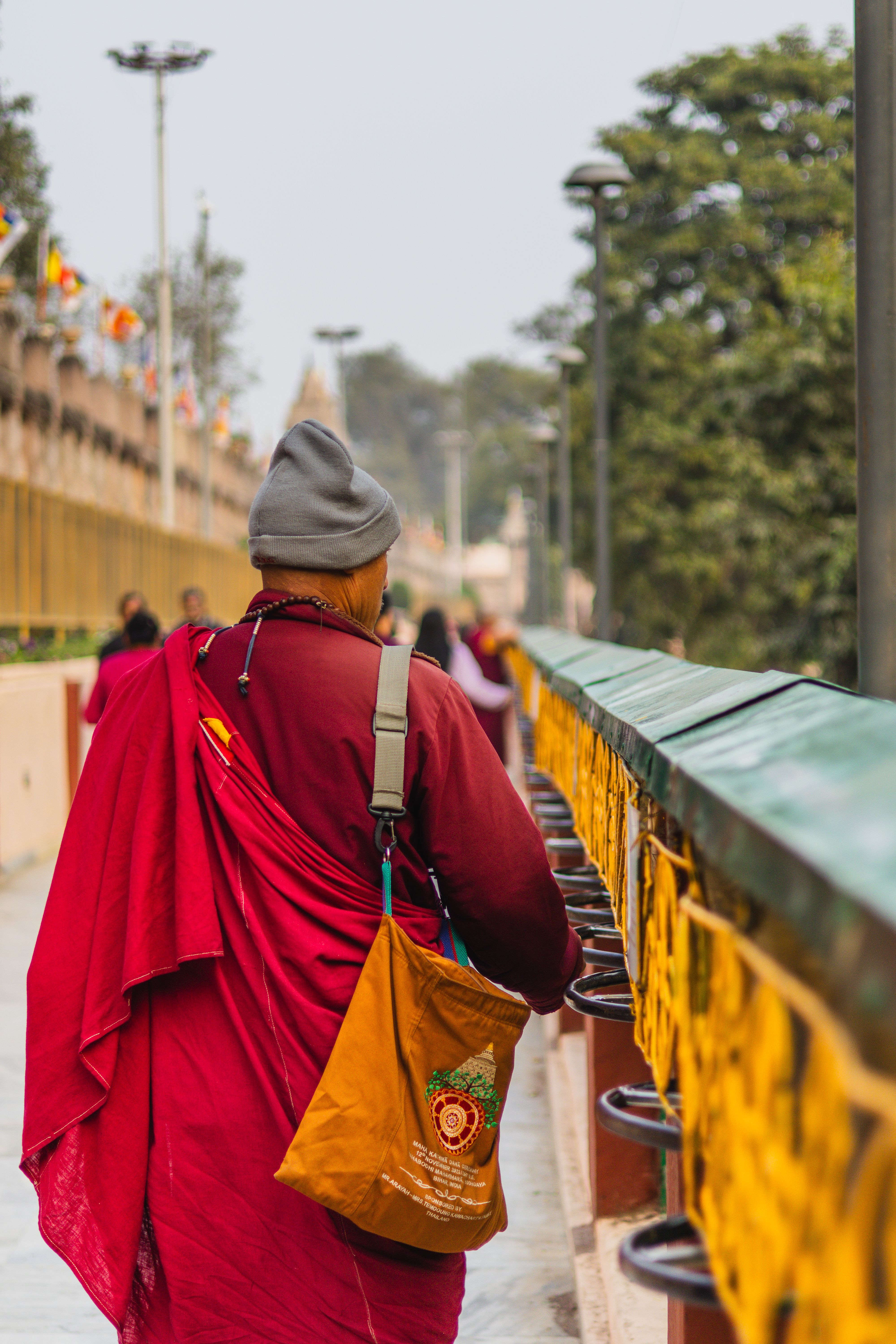 Buddhist Monk Walking in Monastery Garden Path · Free Stock Photo