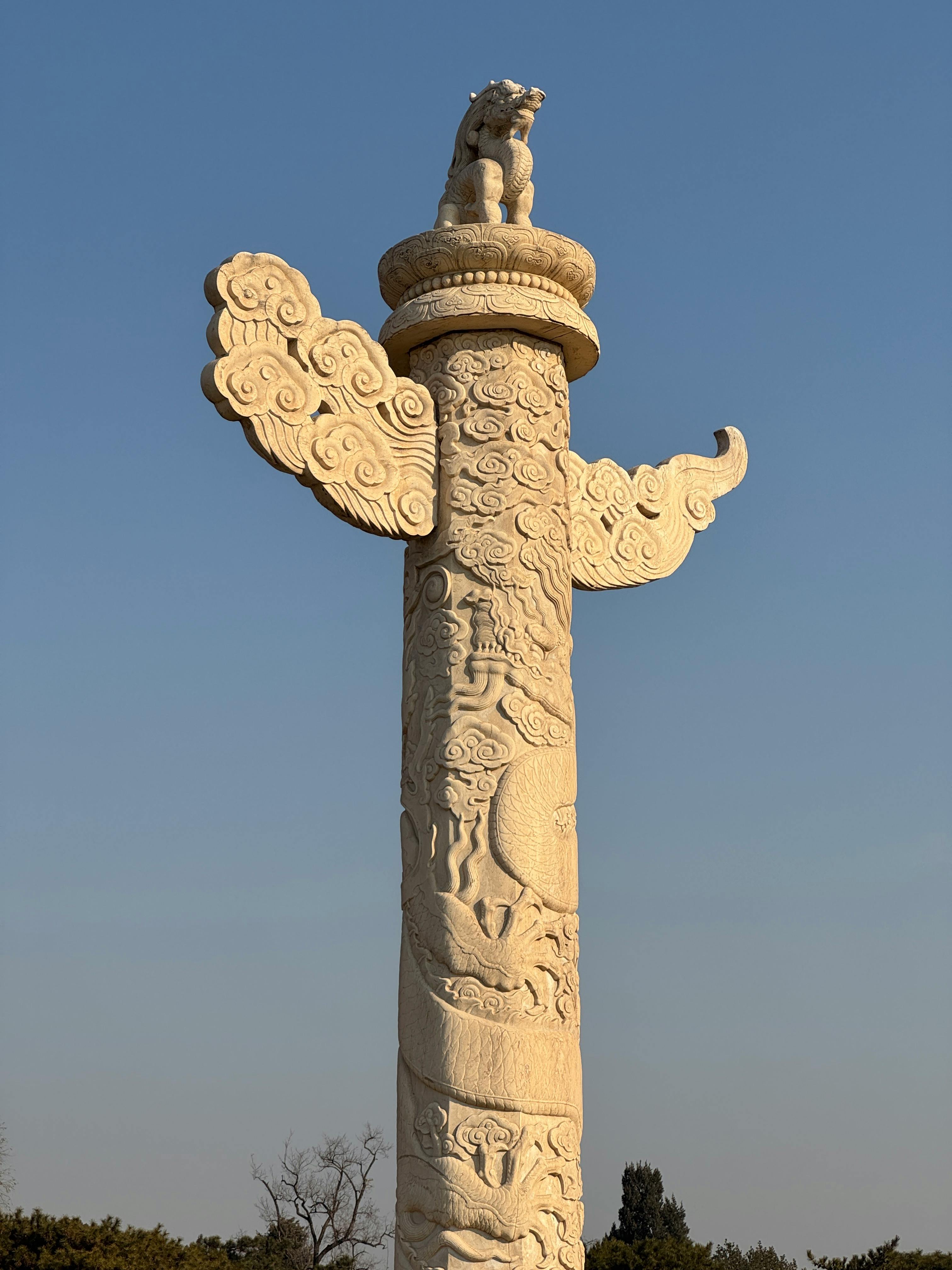 Ancient Chinese Stone Column Against Blue Sky · Free Stock Photo