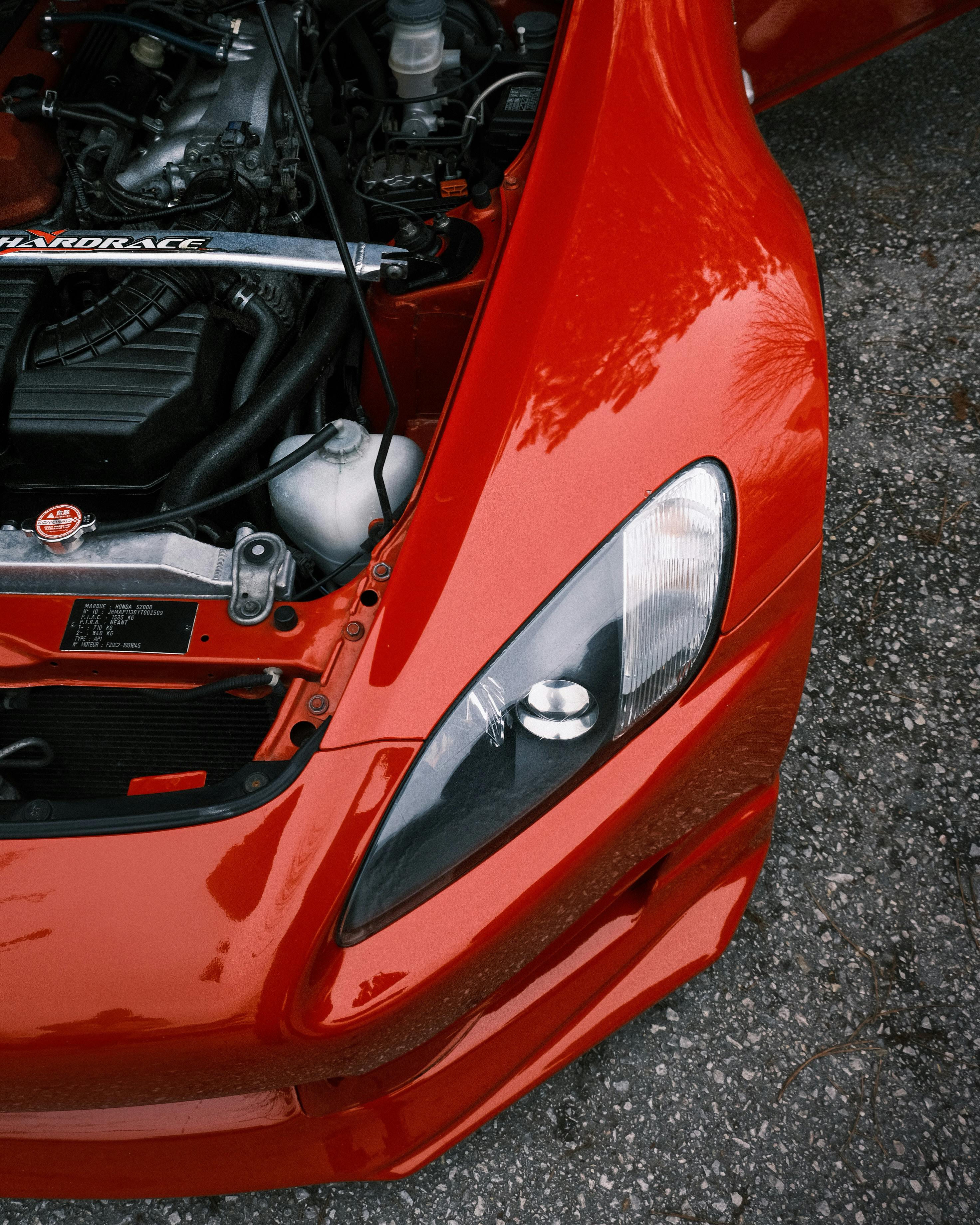 Close-up of Red Sports Car Engine and Headlight · Free Stock Photo