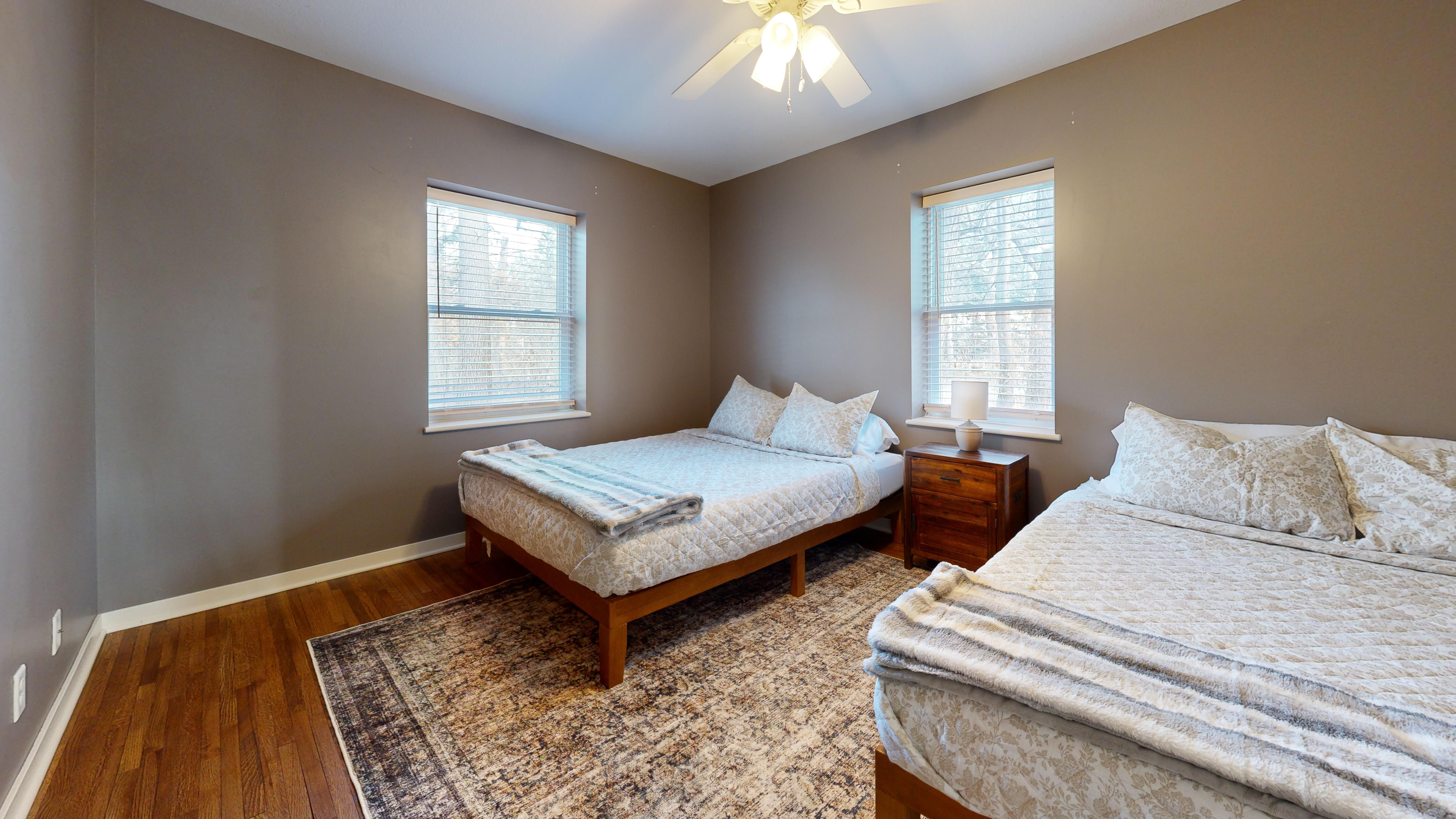 Cozy Modern Bedroom with Double Beds and Warm Lighting · Free Stock Photo