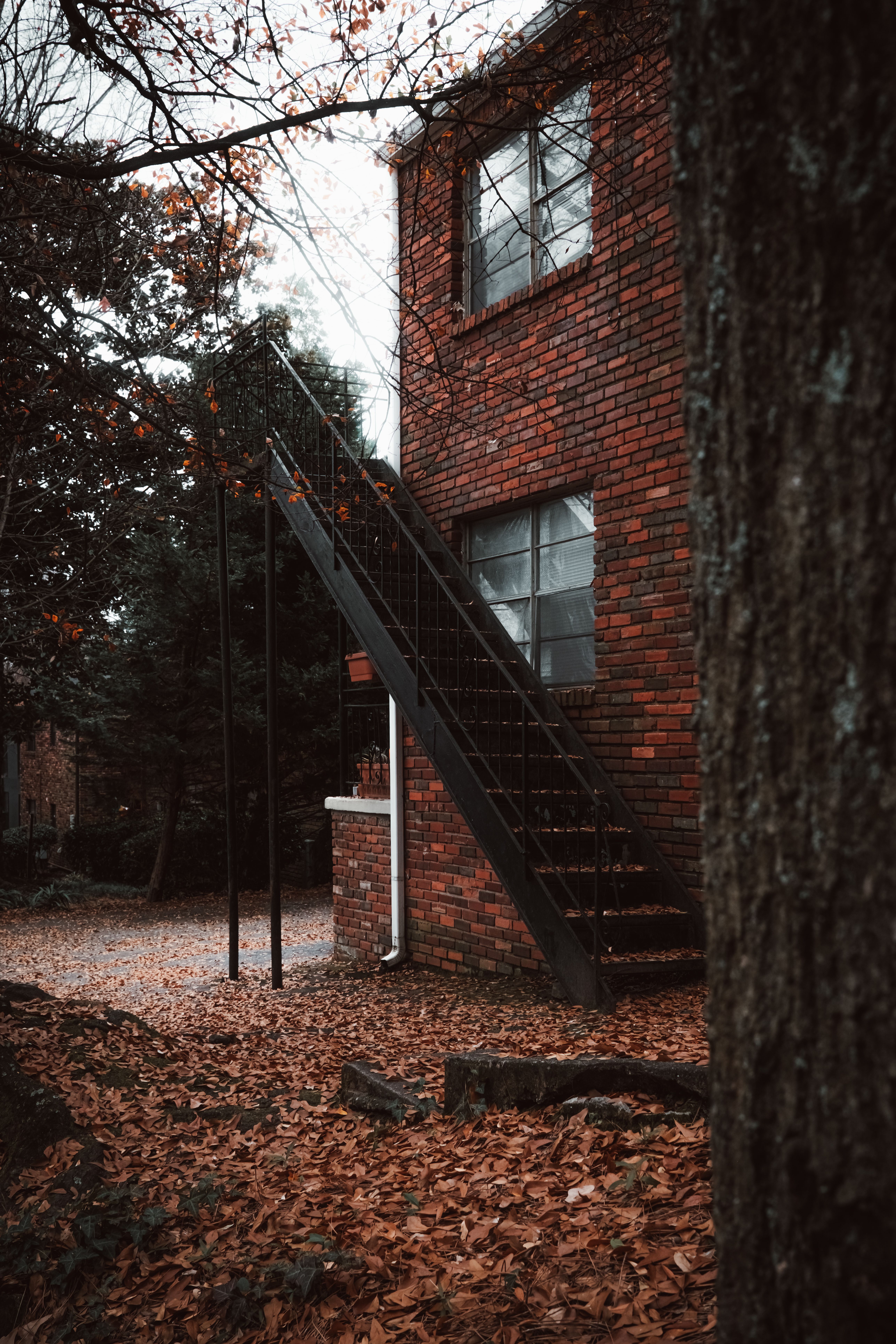 Brick Building with Outdoor Staircase in Autumn · Free Stock Photo