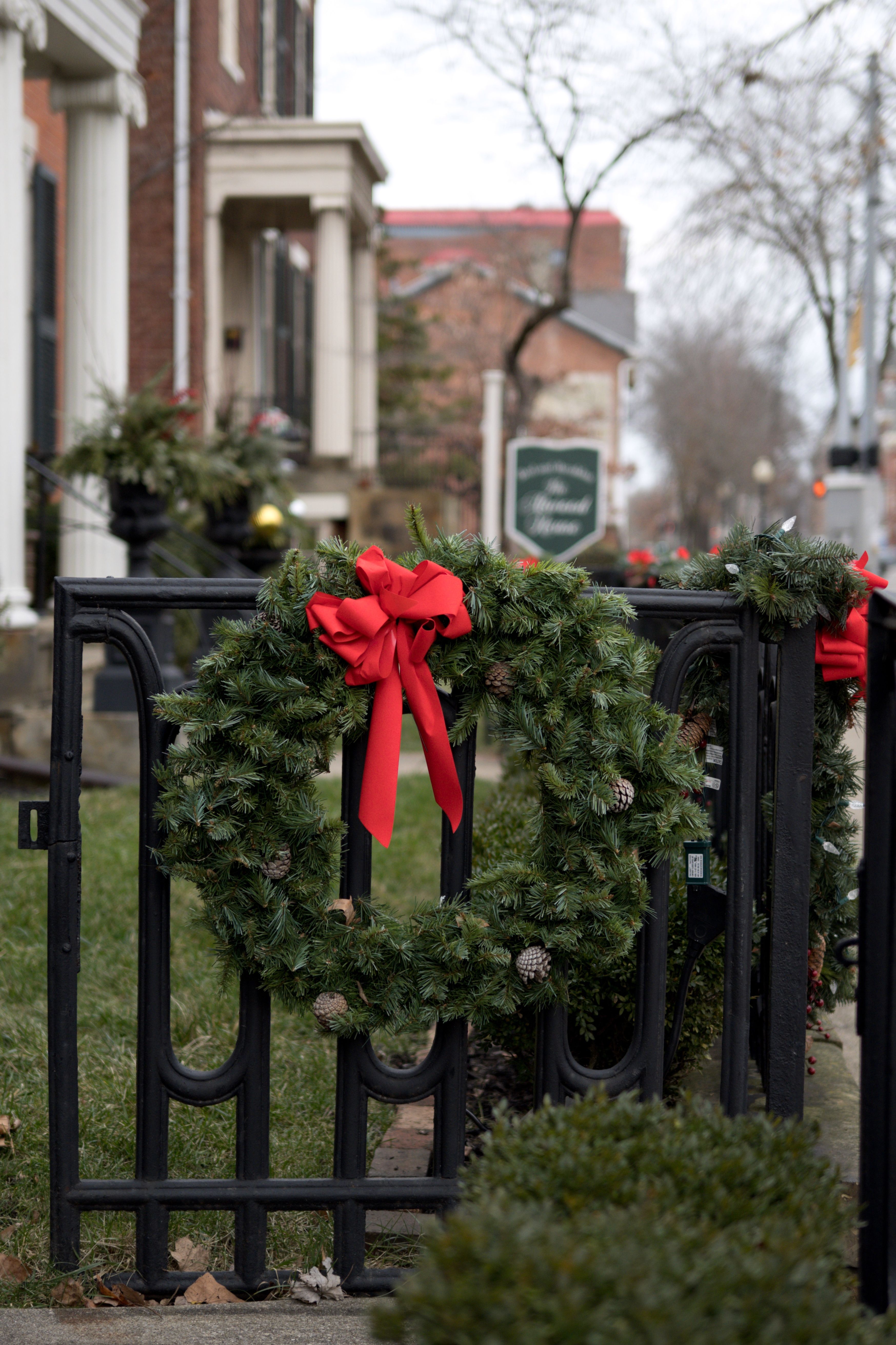 Festive Christmas Wreath on Iron Gate Outdoors · Free Stock Photo