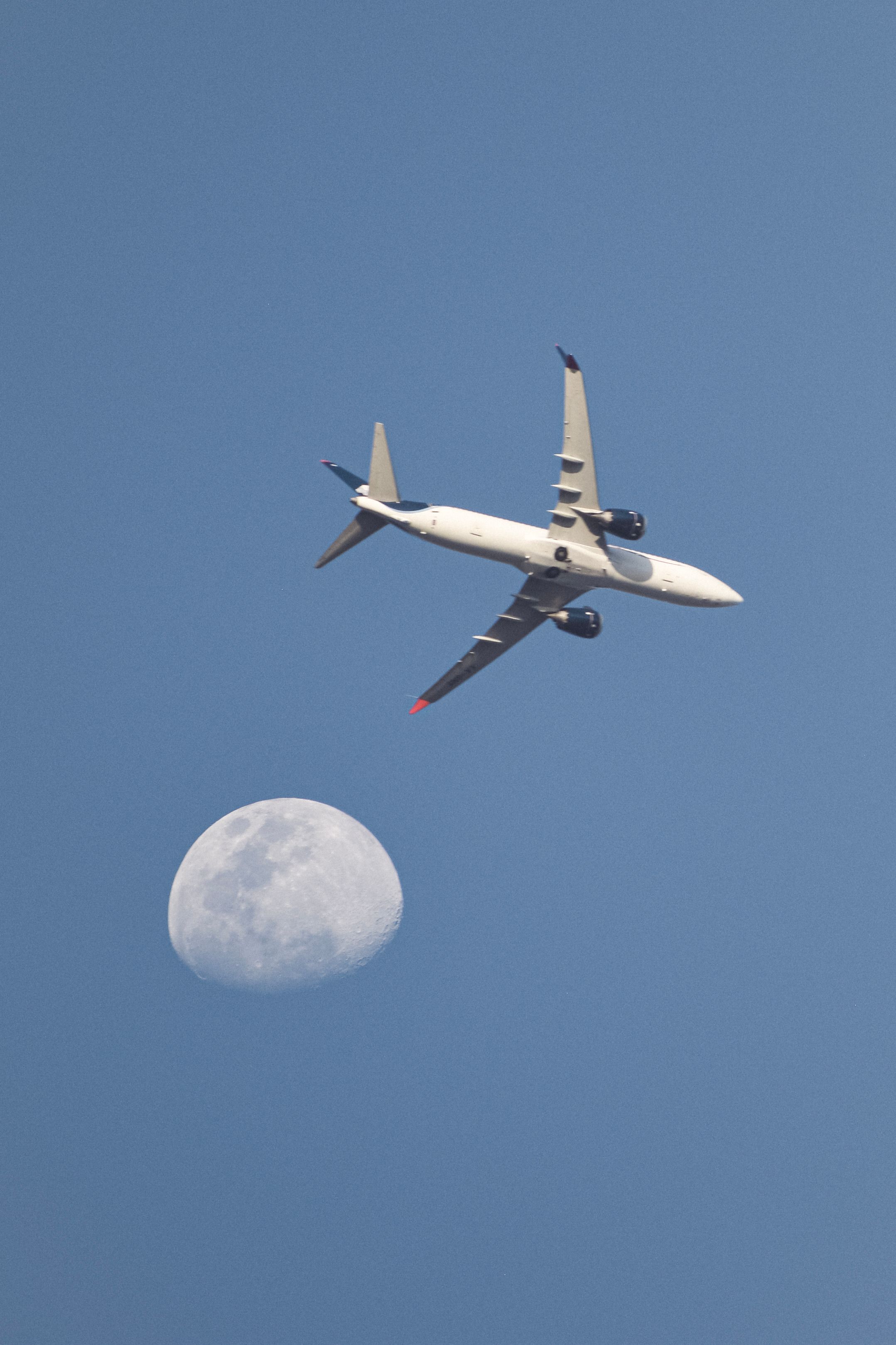 Airplane Flying Over Moon in Clear Sky · Free Stock Photo