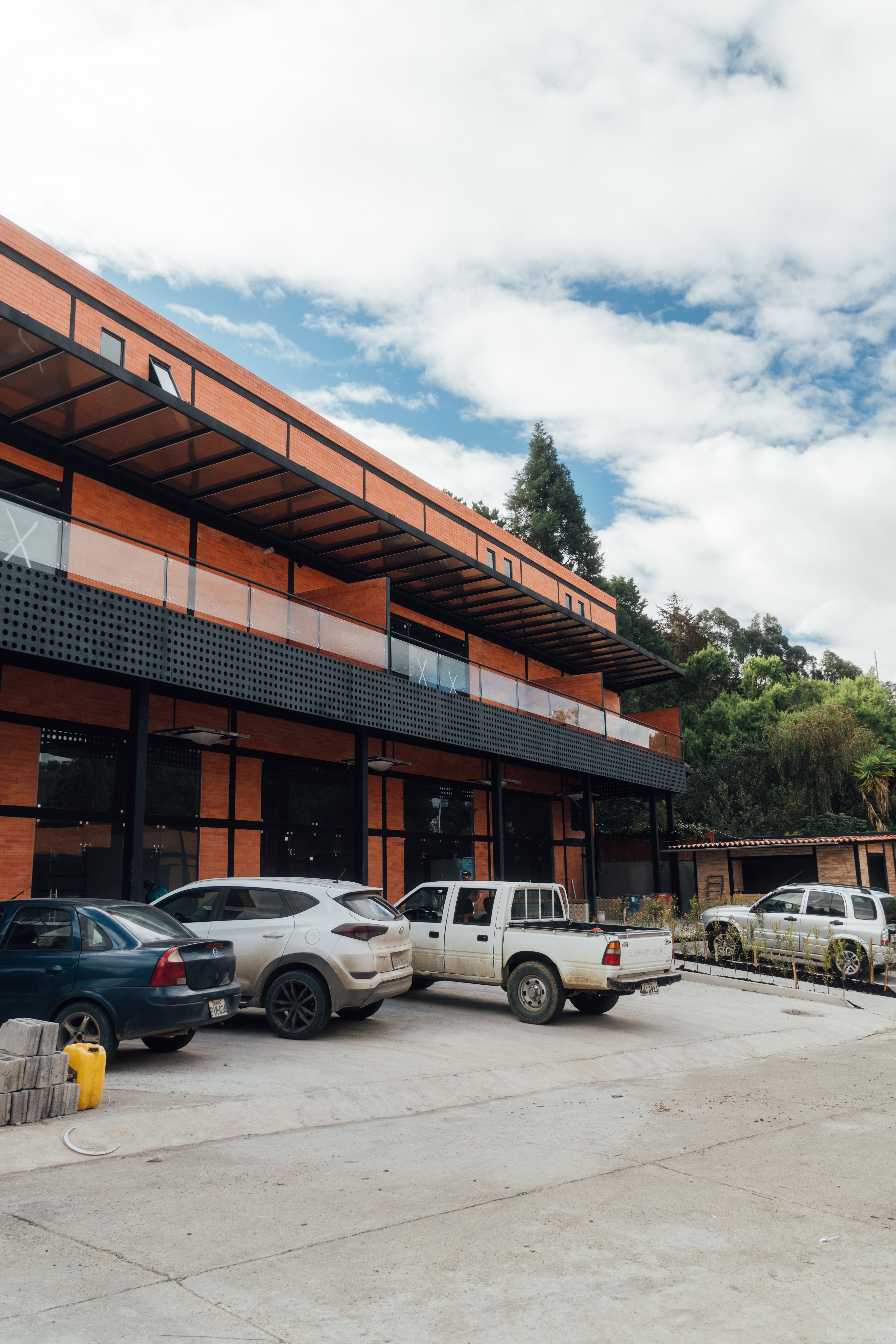 Modern commercial building with parking area · Free Stock Photo