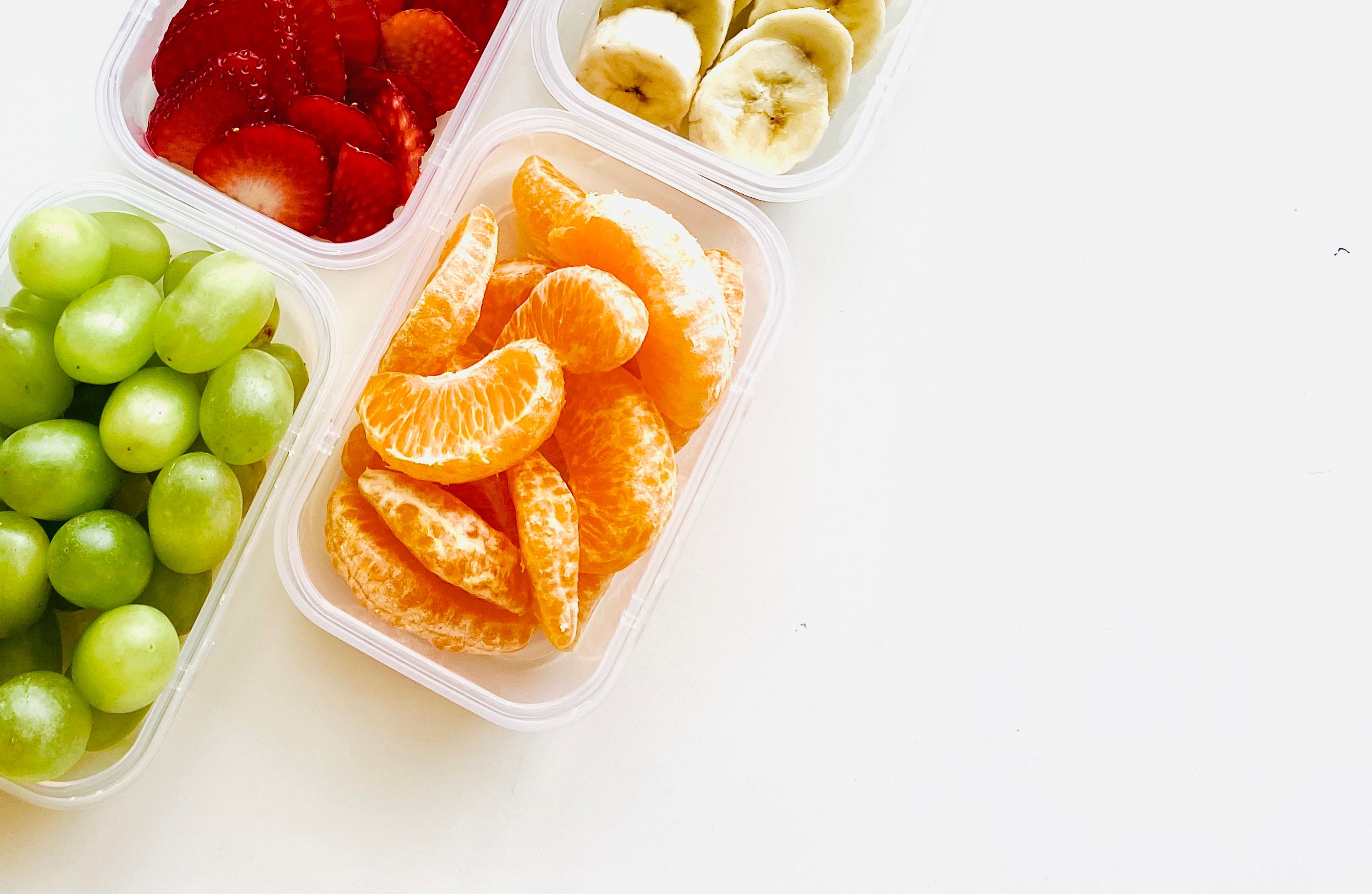 Colorful Assortment of Fresh Fruits in Containers · Free Stock Photo