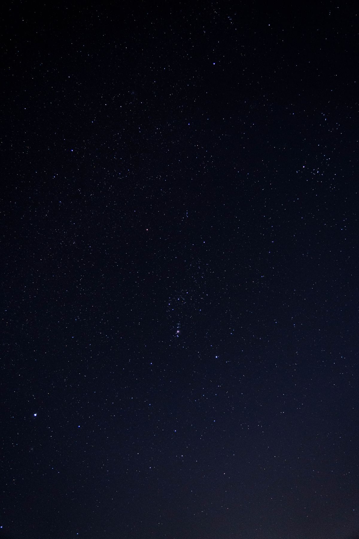 Starry Night Sky with Sparse Clouds · Free Stock Photo