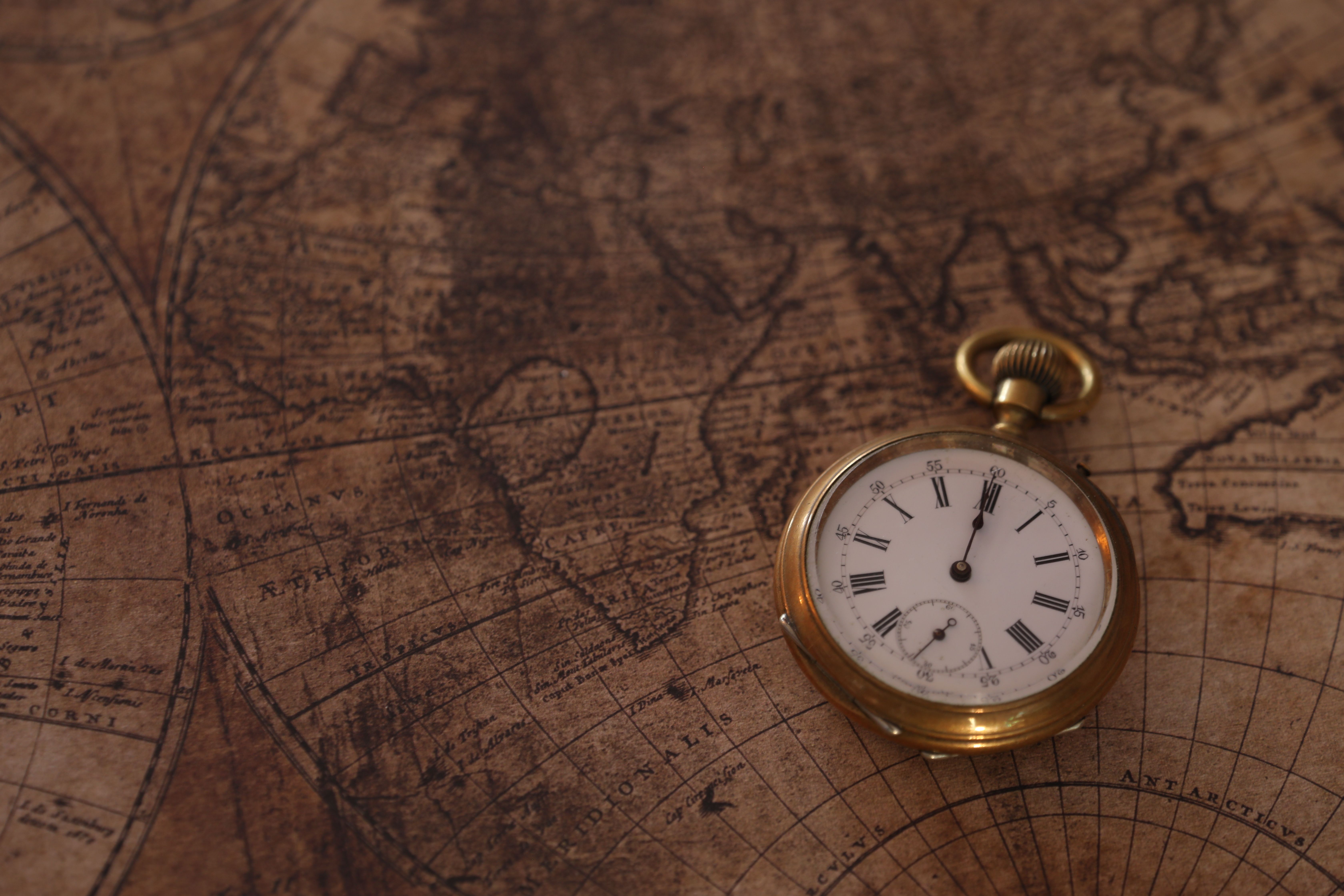 Vintage Pocket Watch on an Antique World Map · Free Stock Photo