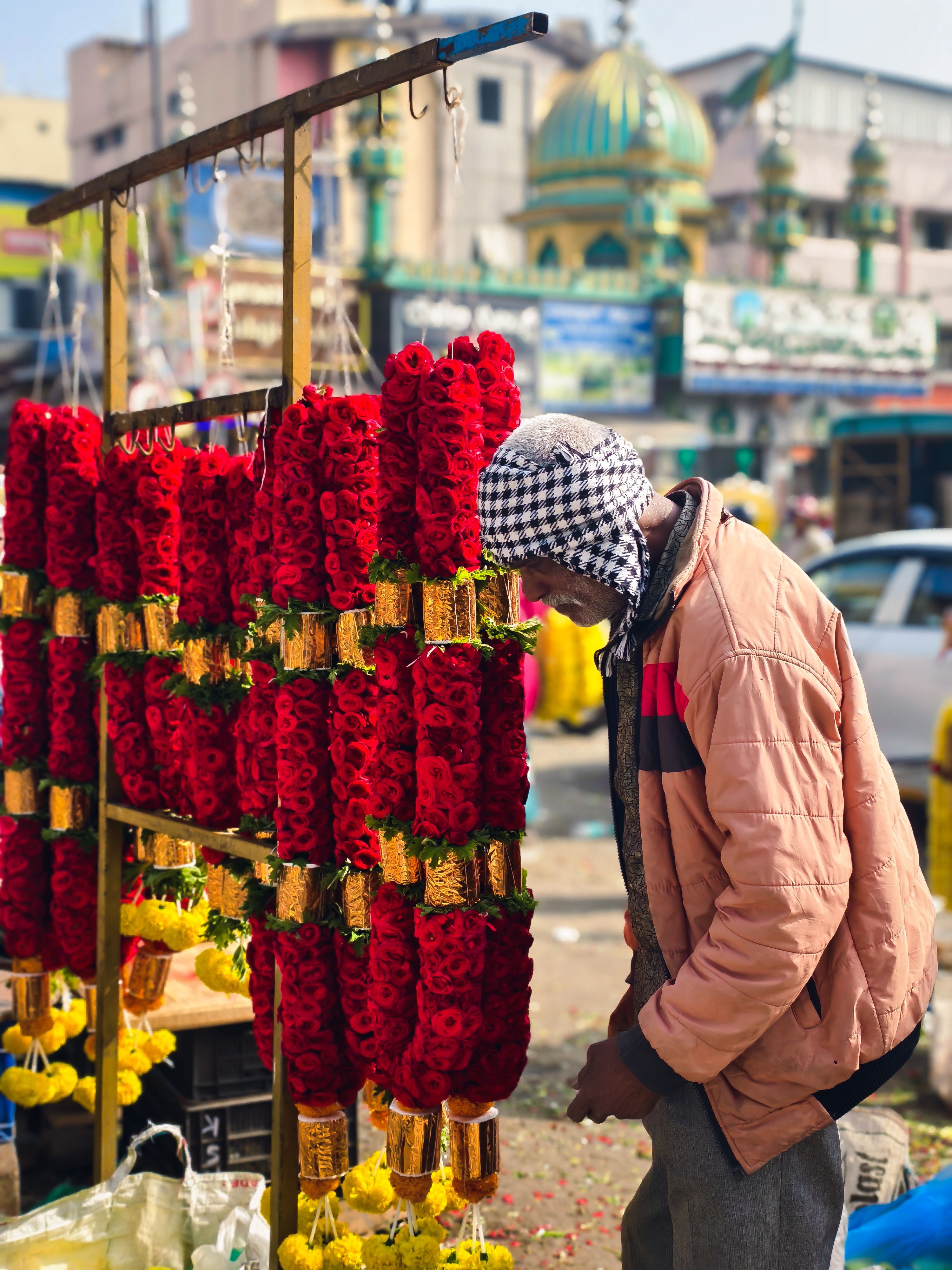 Street Vendor Selling Red Roses in Urban Market · Free Stock Photo