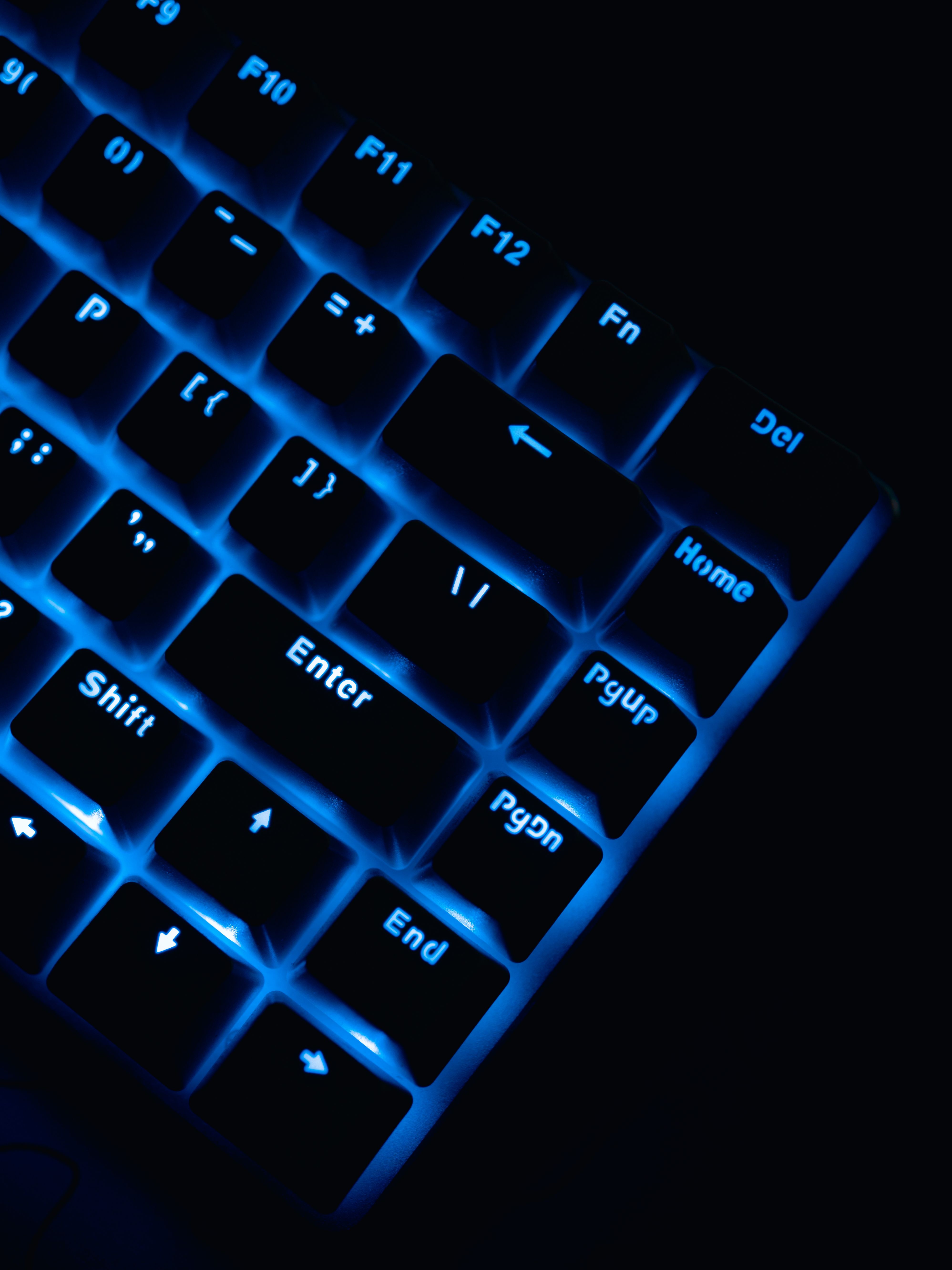 Blue Backlit Keyboard in Dark Setting · Free Stock Photo