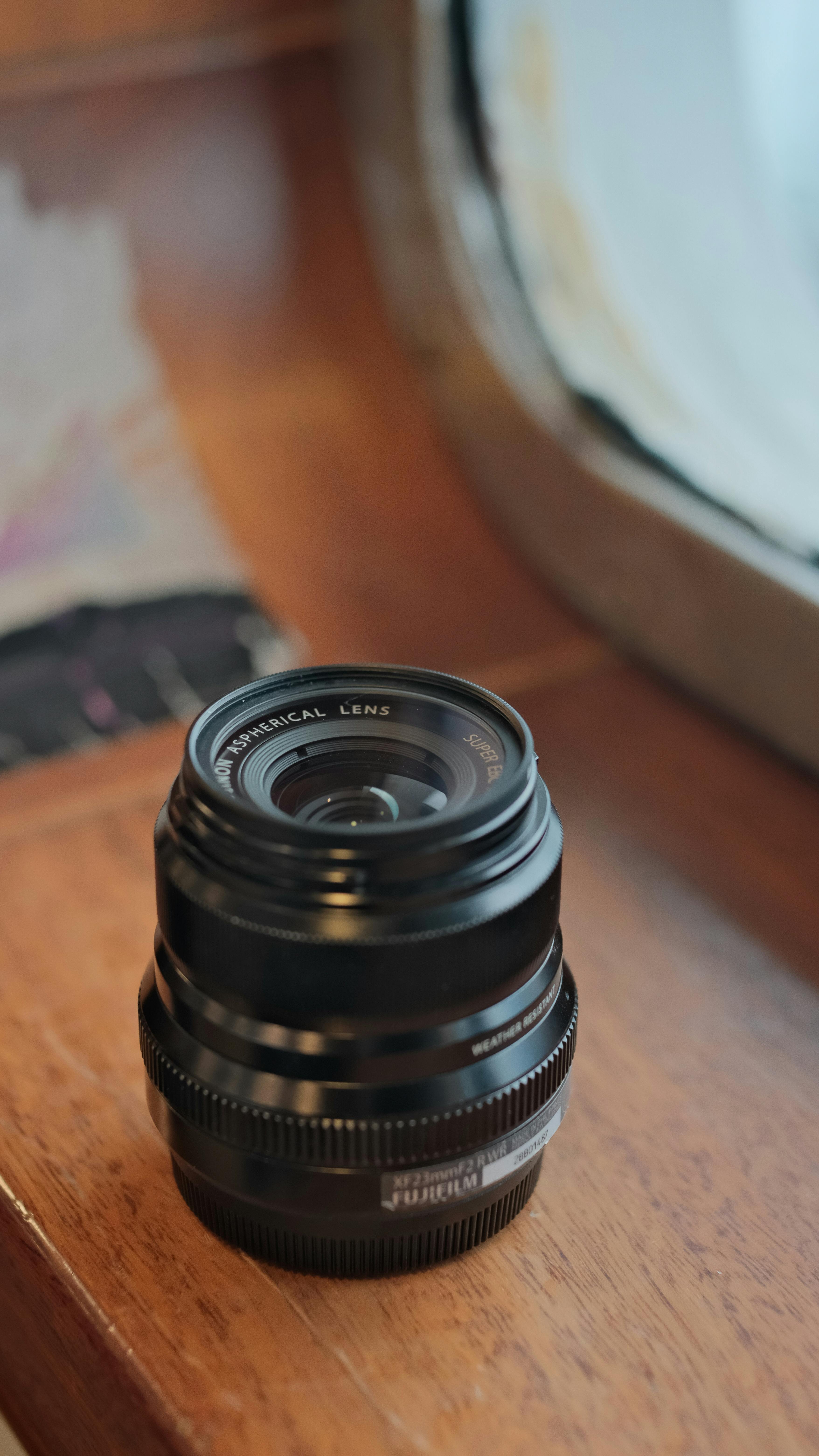 Close-Up of Fujinon Lens on Wooden Surface · Free Stock Photo