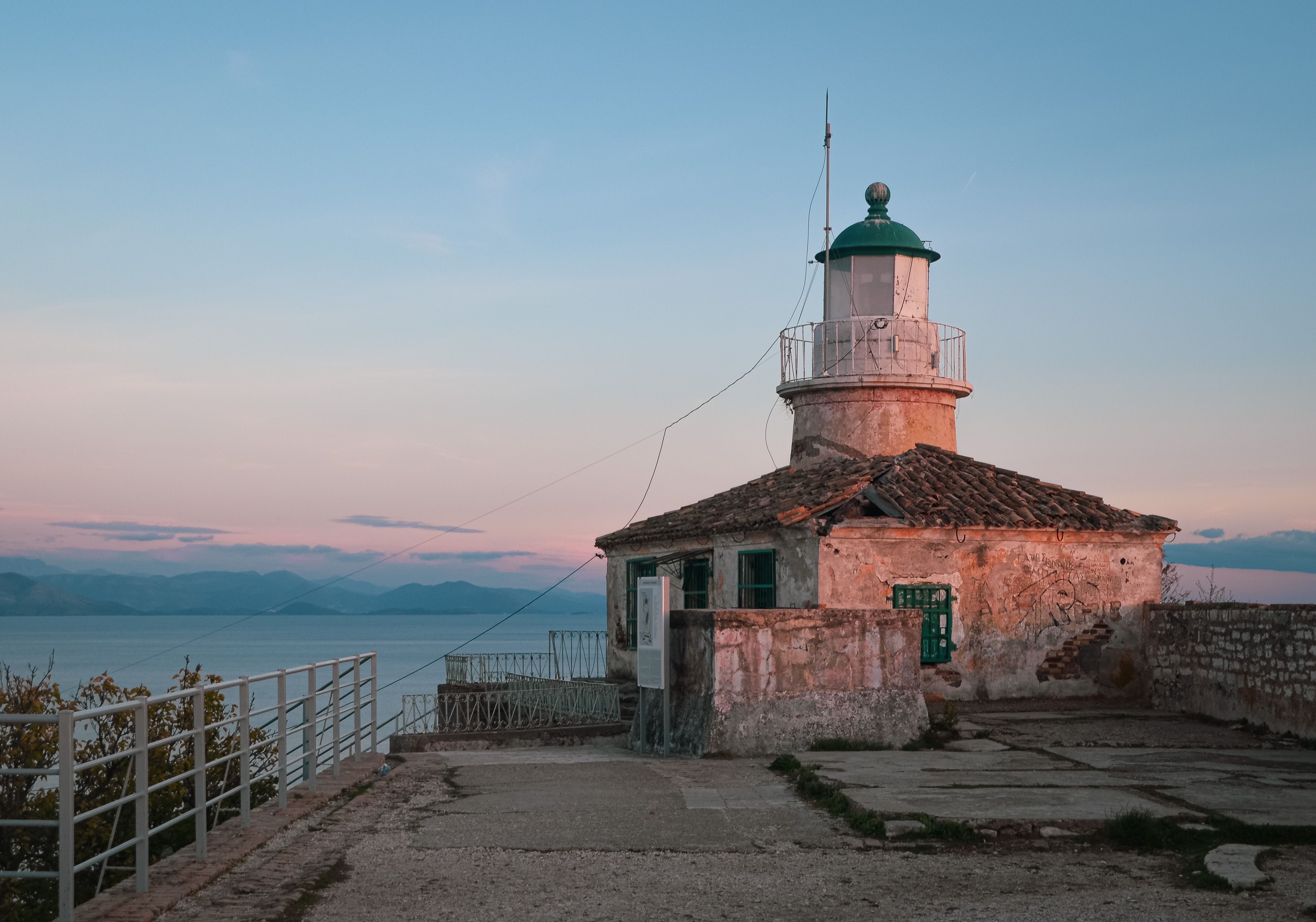 Vintage Lighthouse at Twilight by the Sea · Free Stock Photo