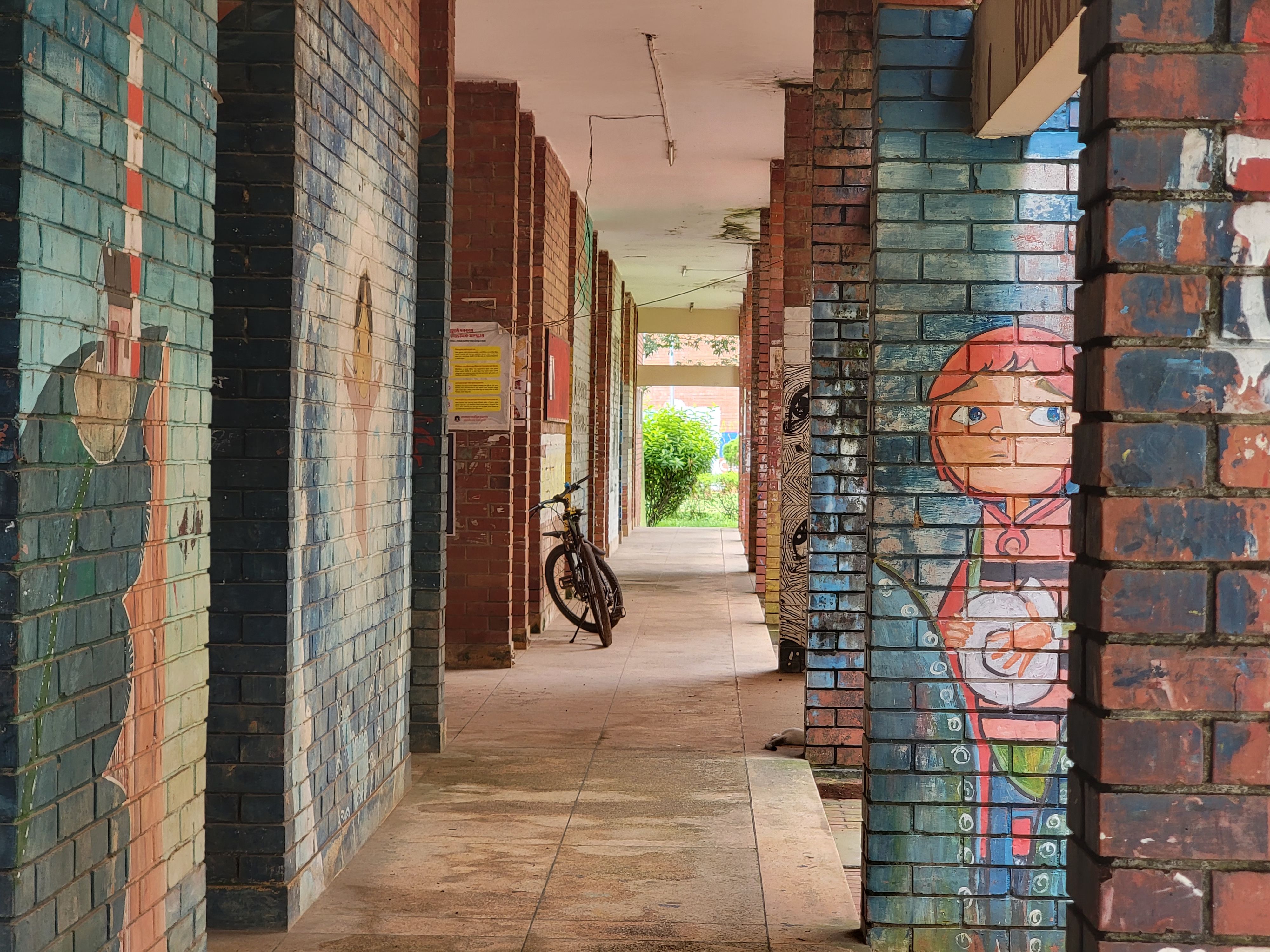 Colorful Corridor with Murals and Bicycle · Free Stock Photo