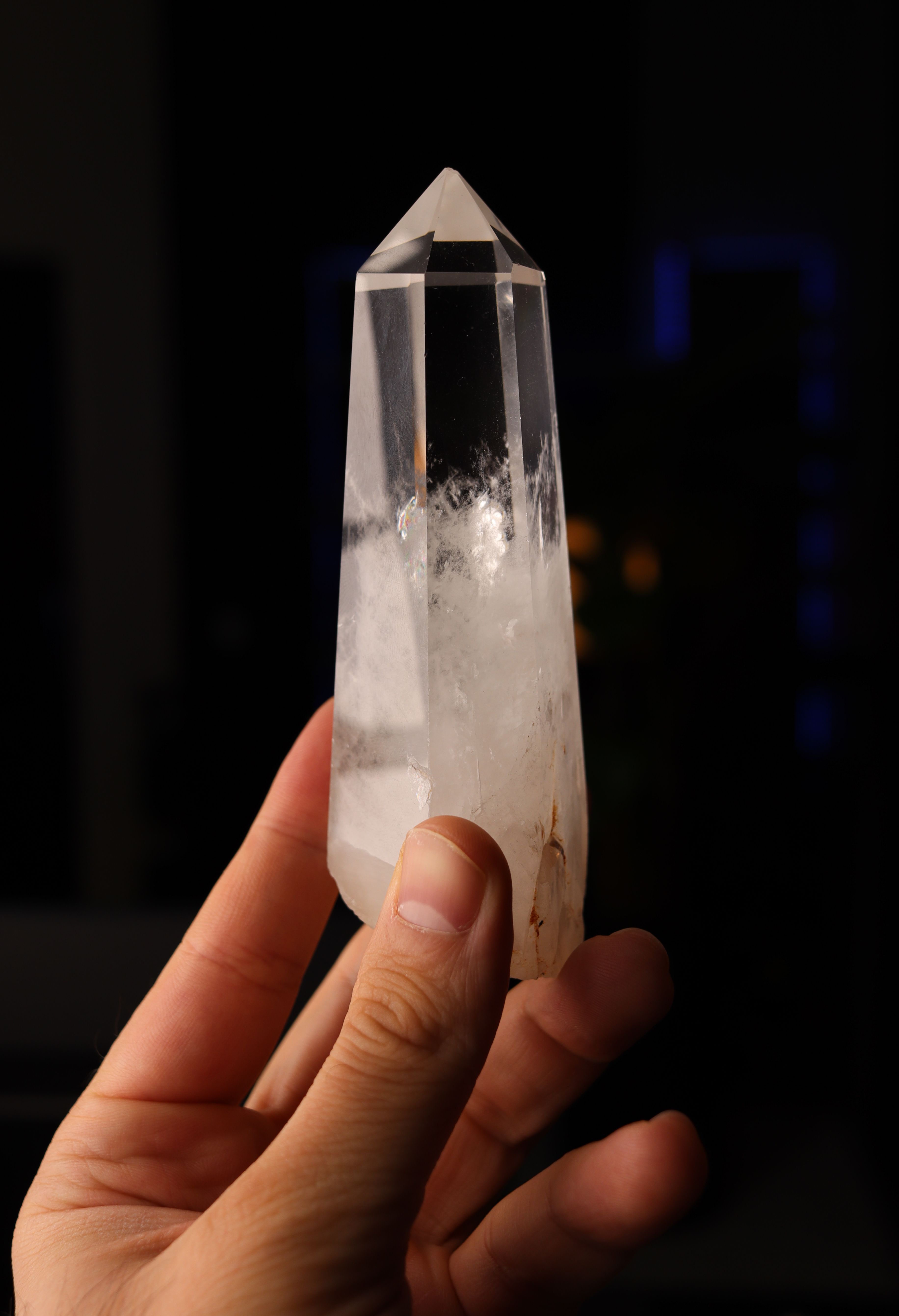 Hand Holding a Clear Quartz Crystal Tower · Free Stock Photo