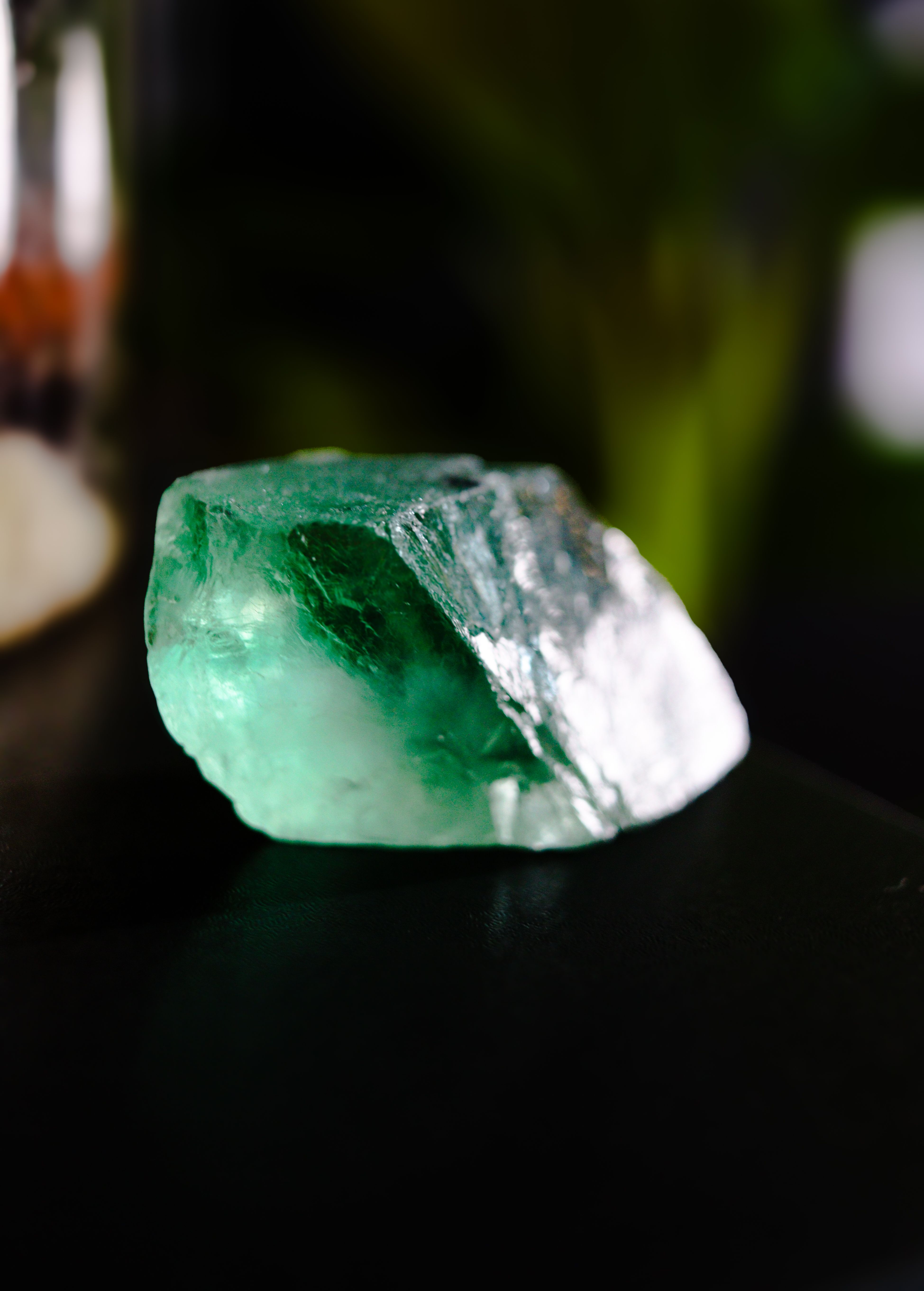 Close-Up of Raw Emerald Crystal on Dark Surface · Free Stock Photo