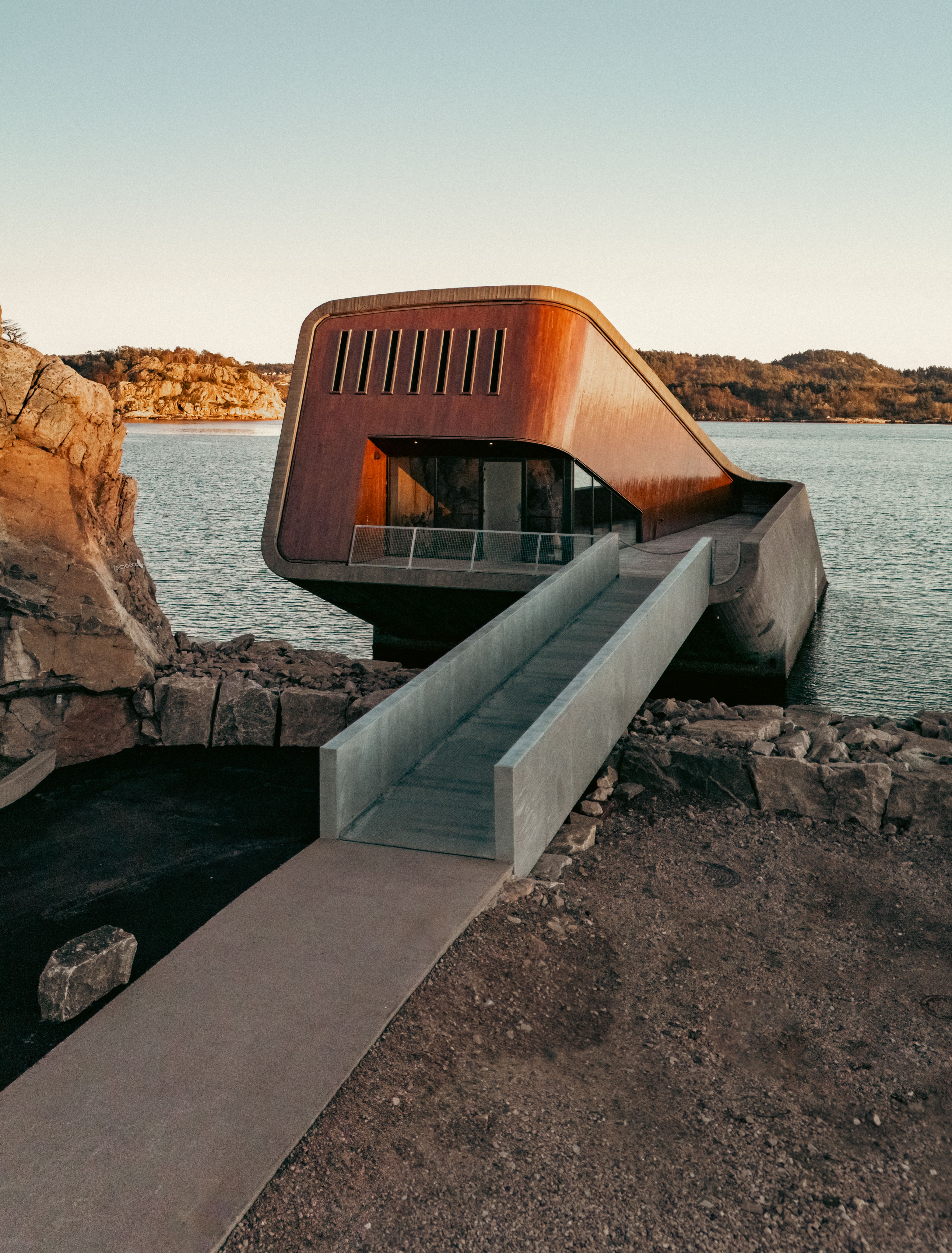 Modern Architectural Waterfront Structure at Sunset · Free Stock Photo