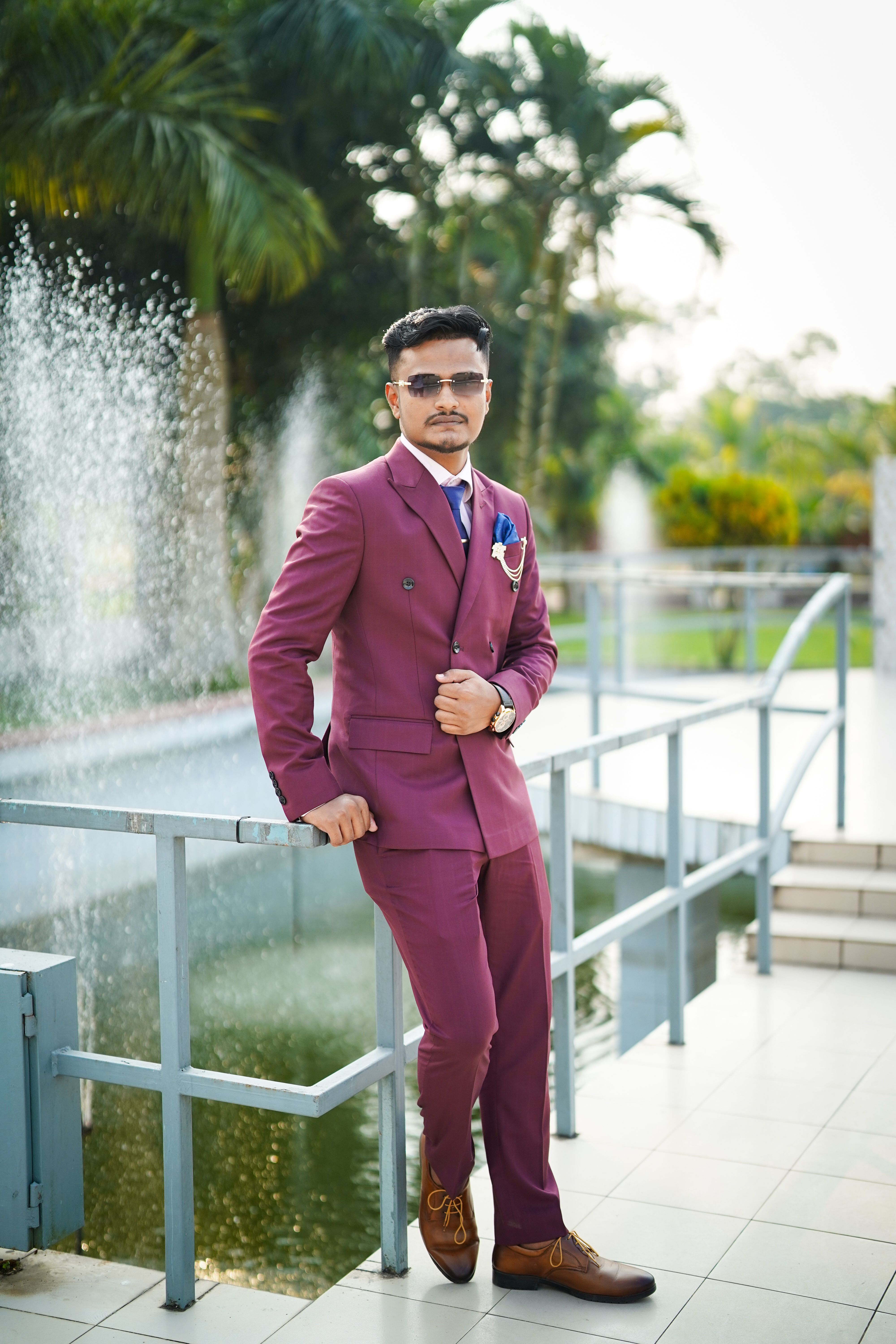 Stylish Man in Maroon Suit by Outdoor Fountain · Free Stock Photo